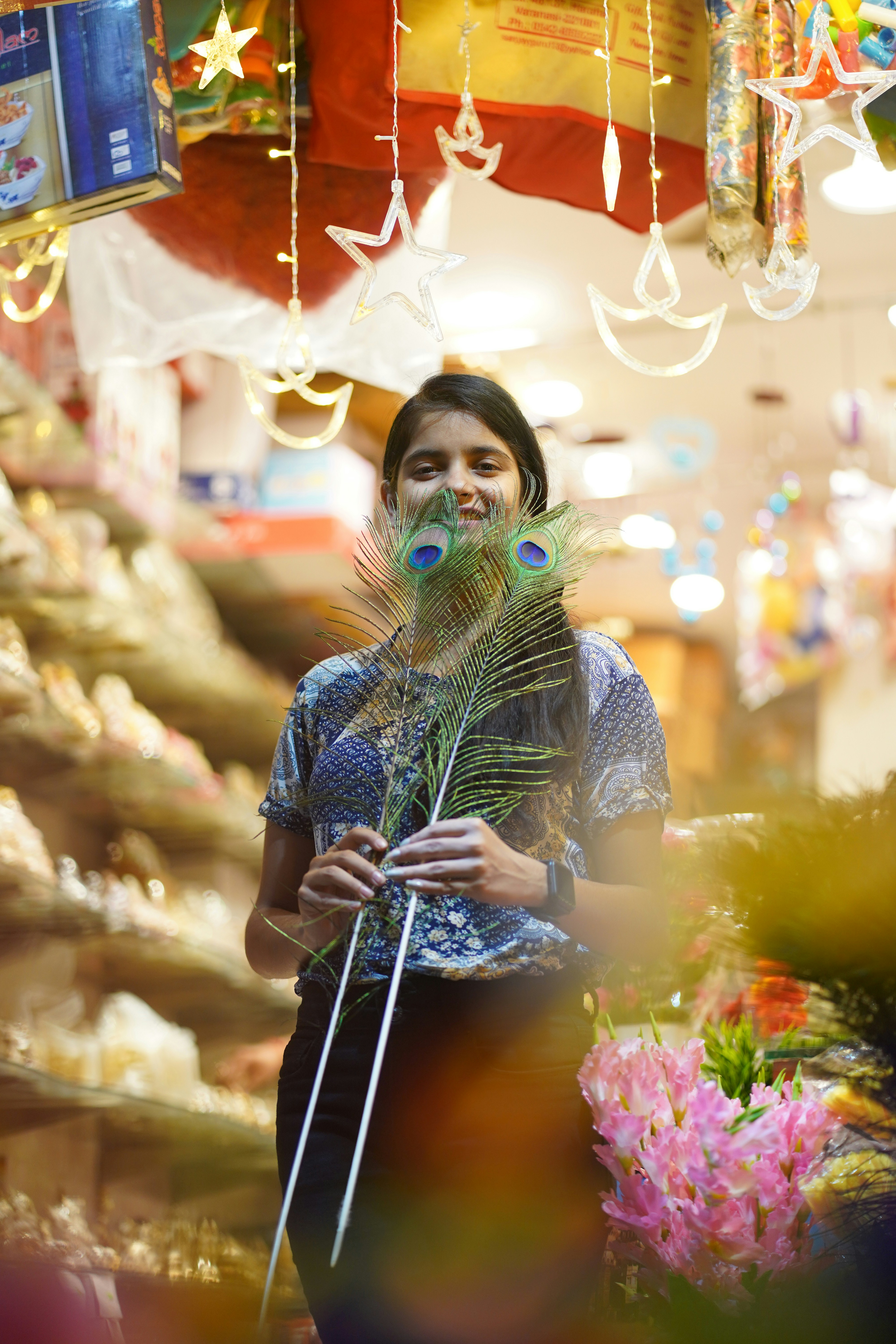 Peacock Feathers and a Hidden Smile in a Festive Market Aisle