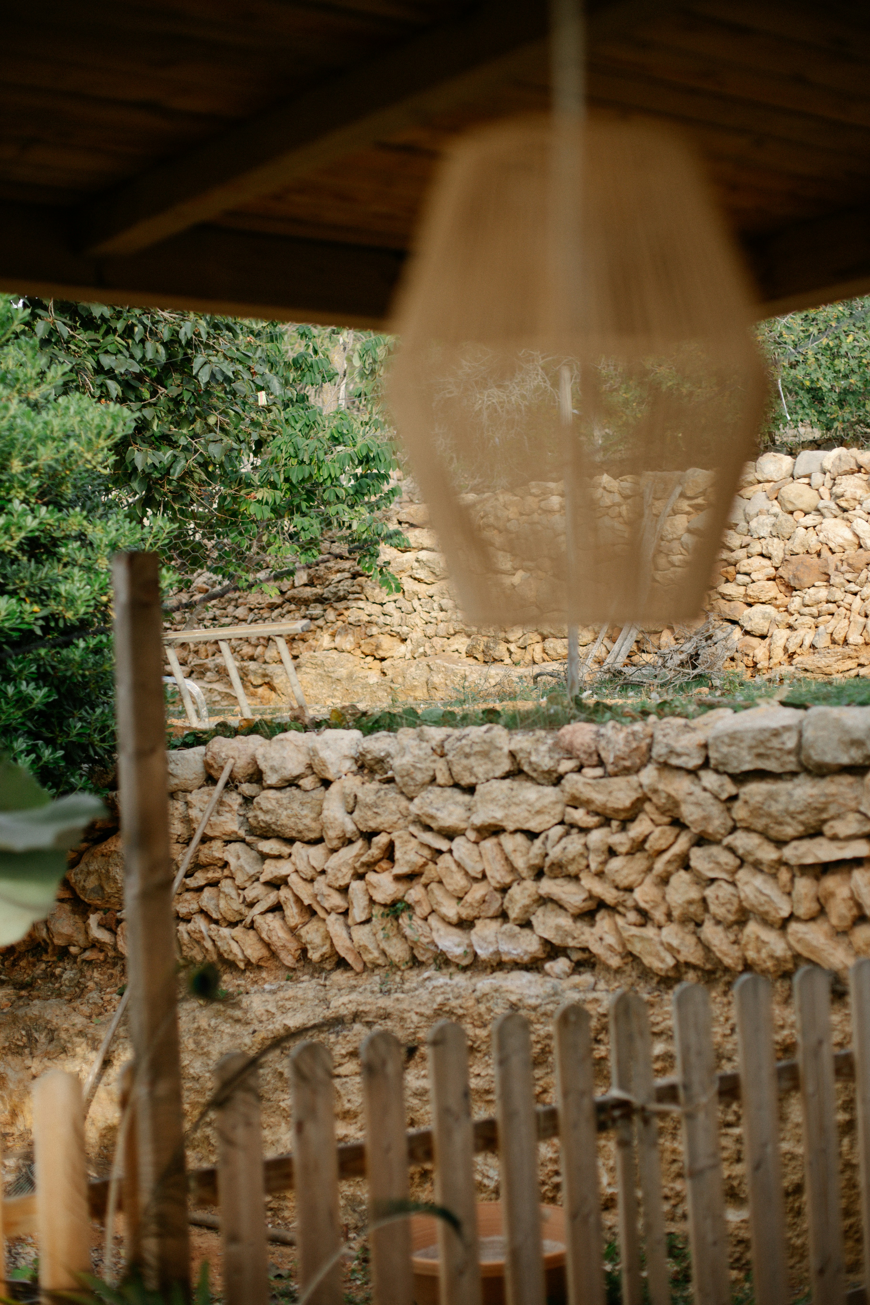 Lantern Blur Over a Sunlit Stone Courtyard