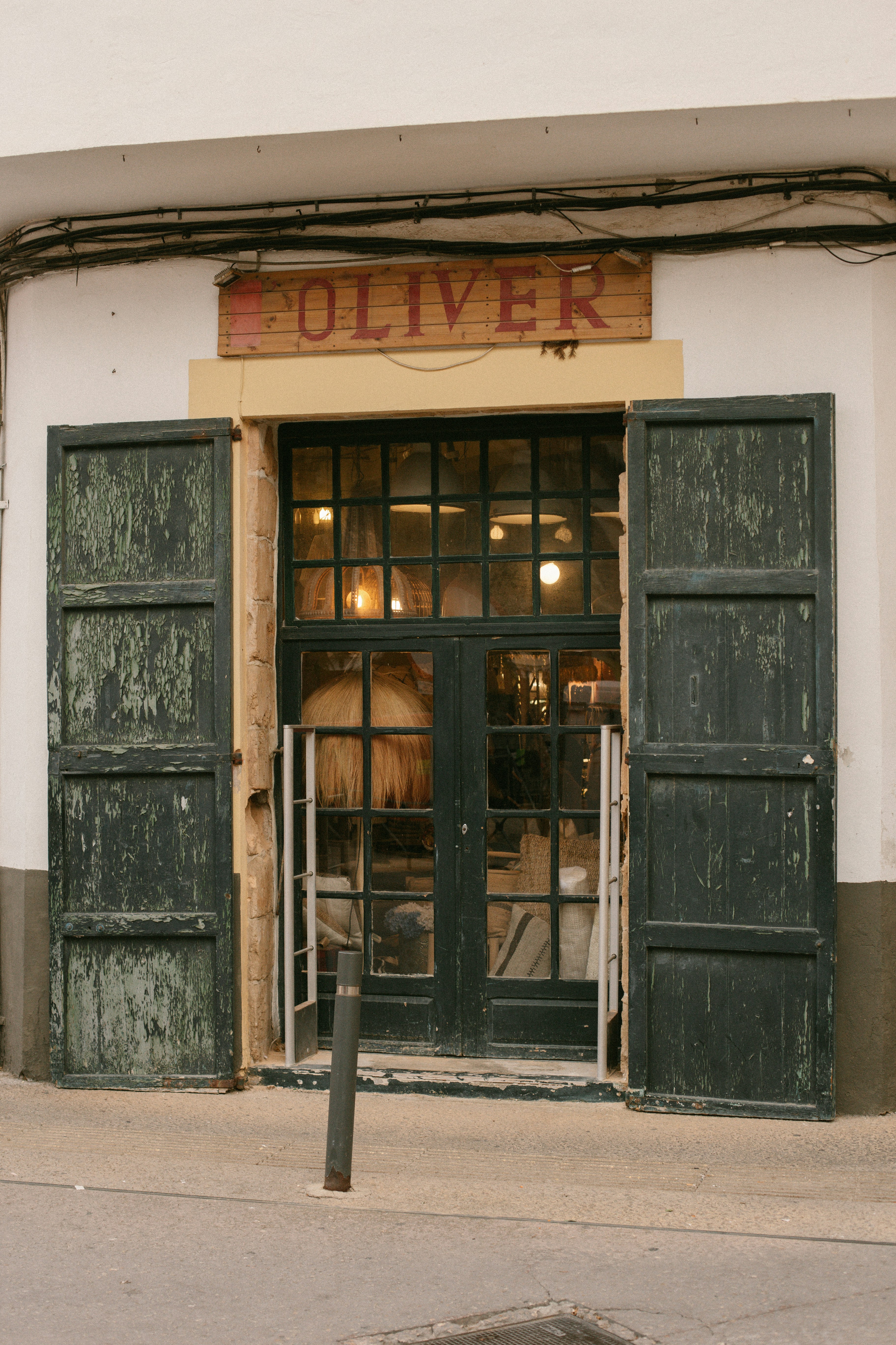 A store front with green shutters on a street corner photo – Free Door ...
