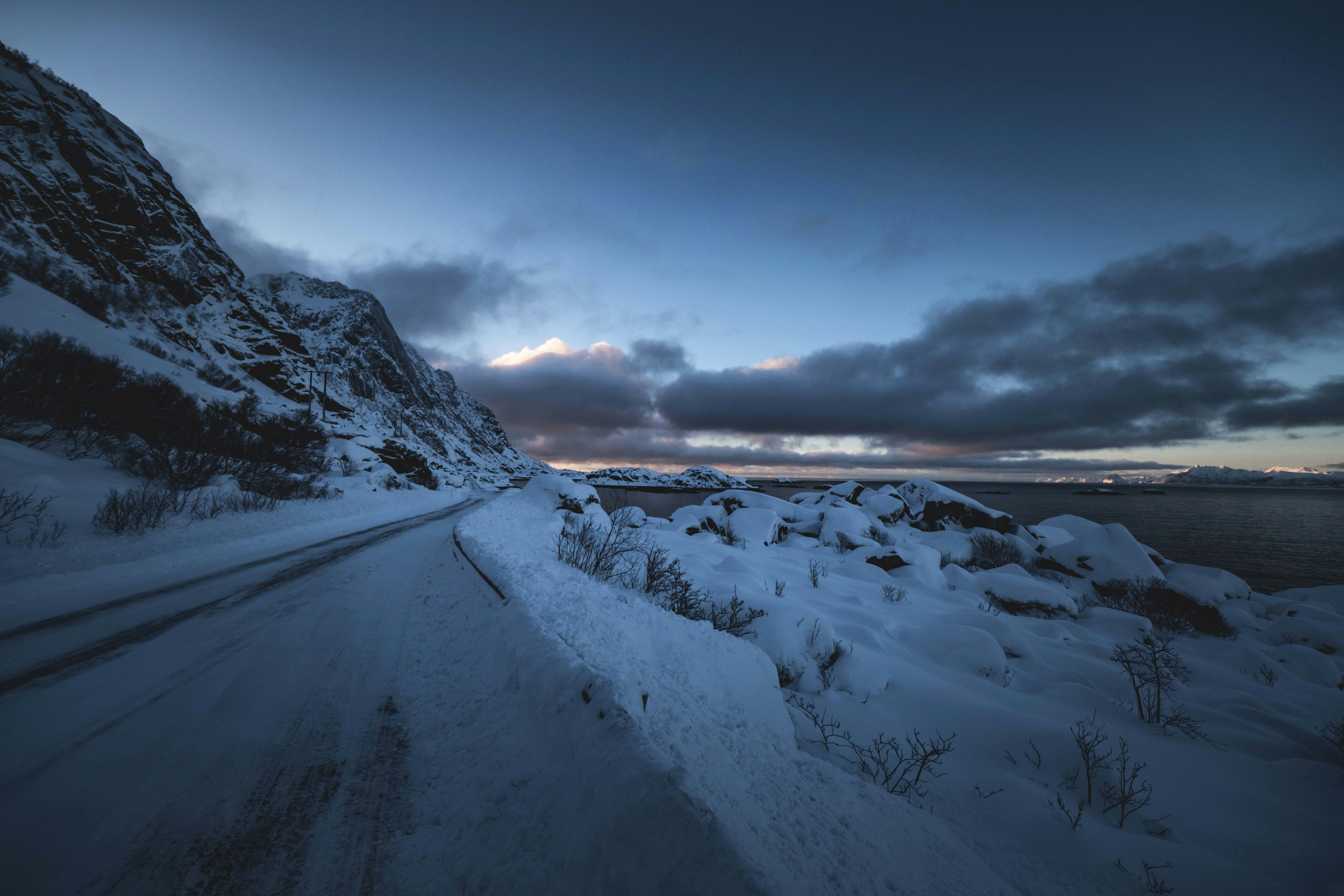 A snow covered mountain with a sky background photo – Free Winter Image ...