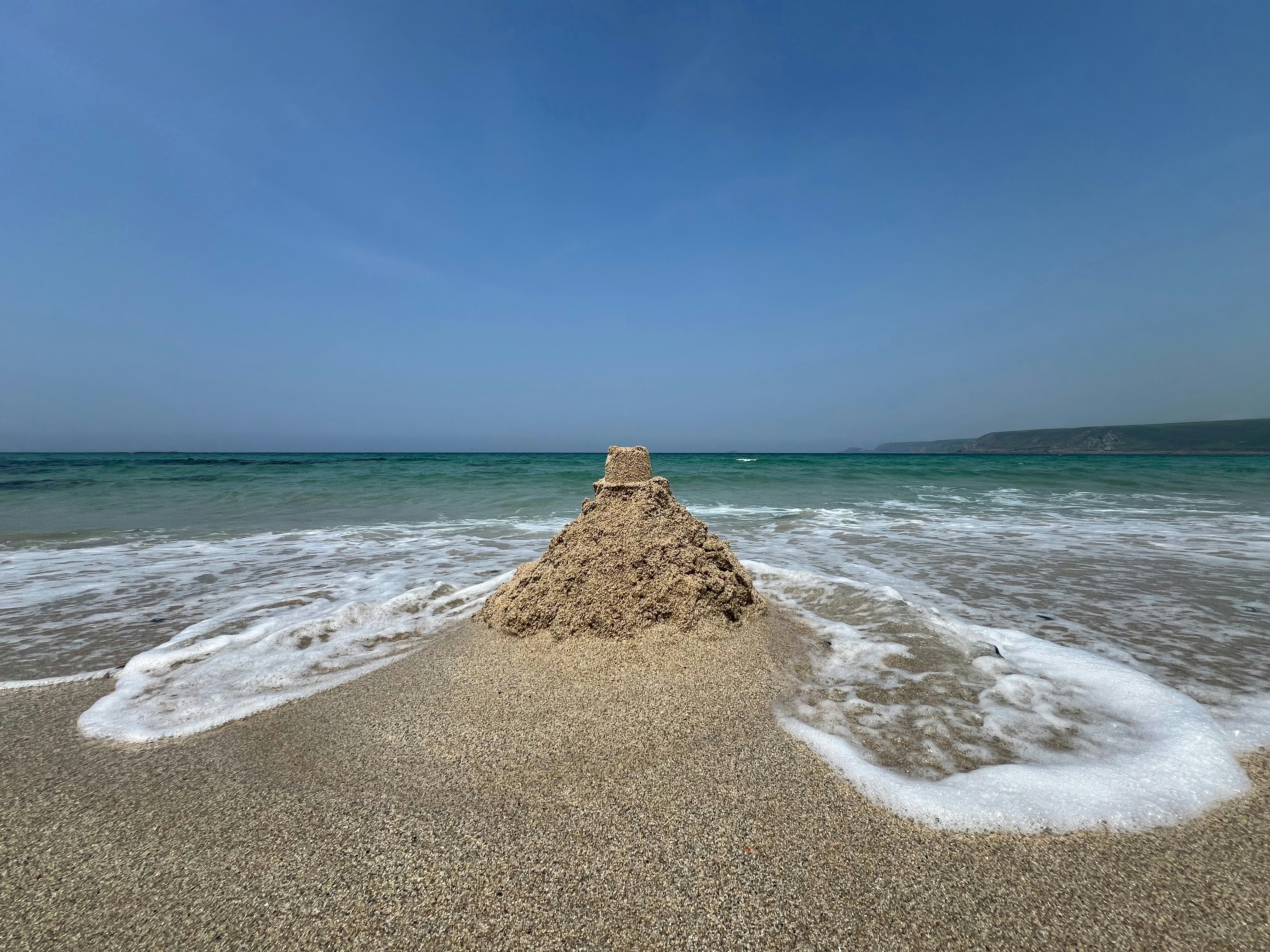 Sand castle in the waves