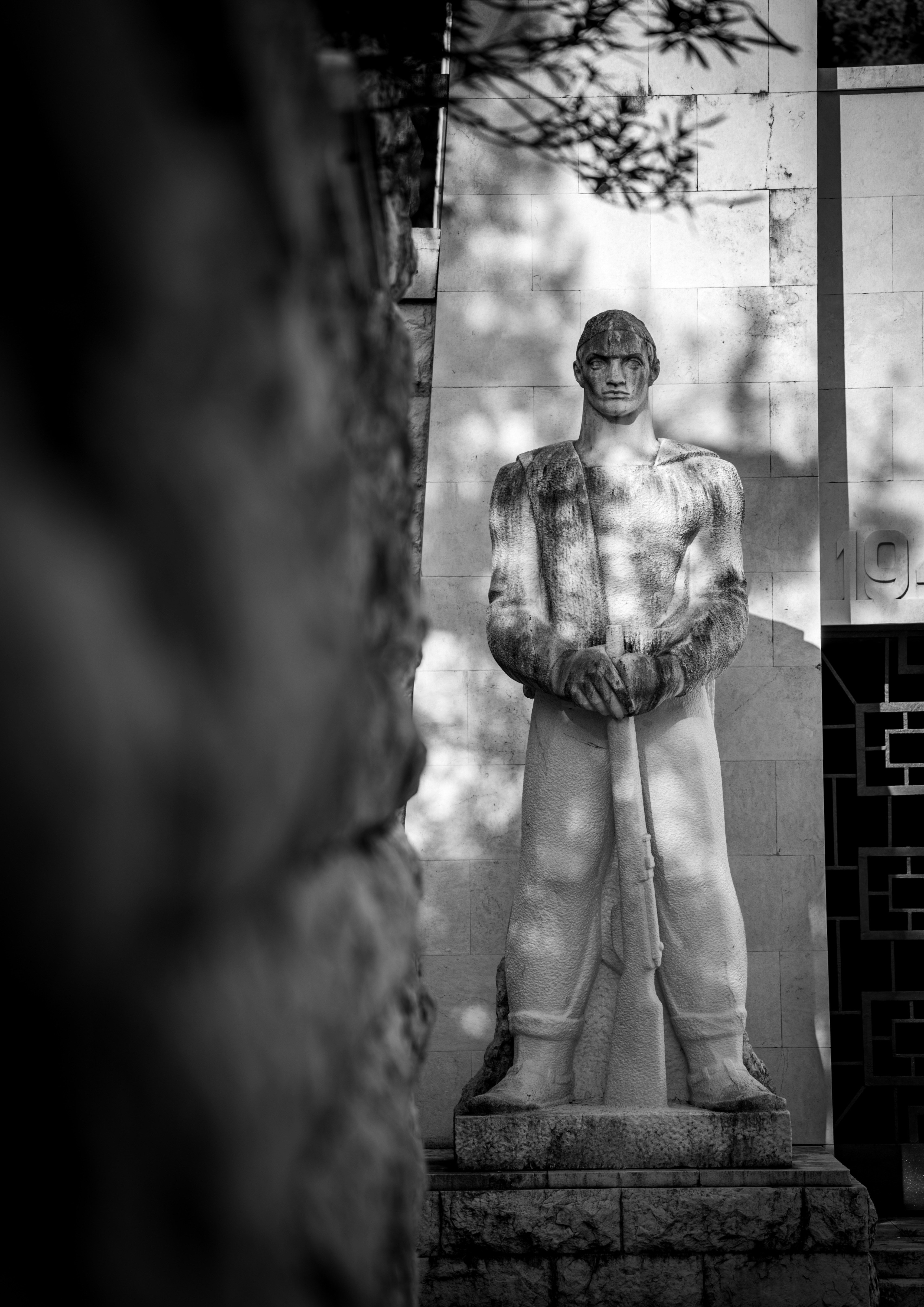 Dappled Light on a Stone Sentinel: Courtyard Portrait