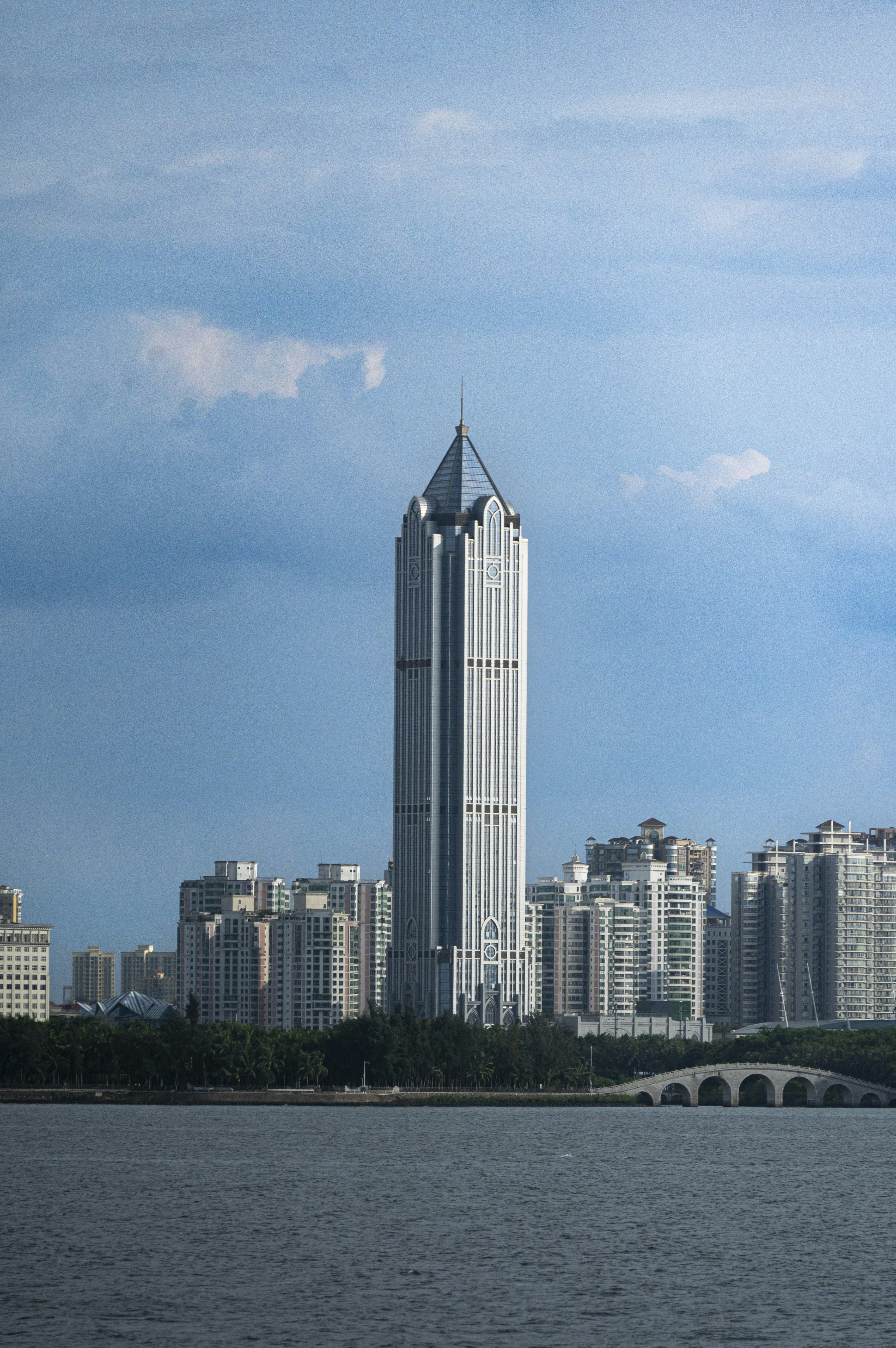 Riverside Monolith: A slender tower rising above the waterline
