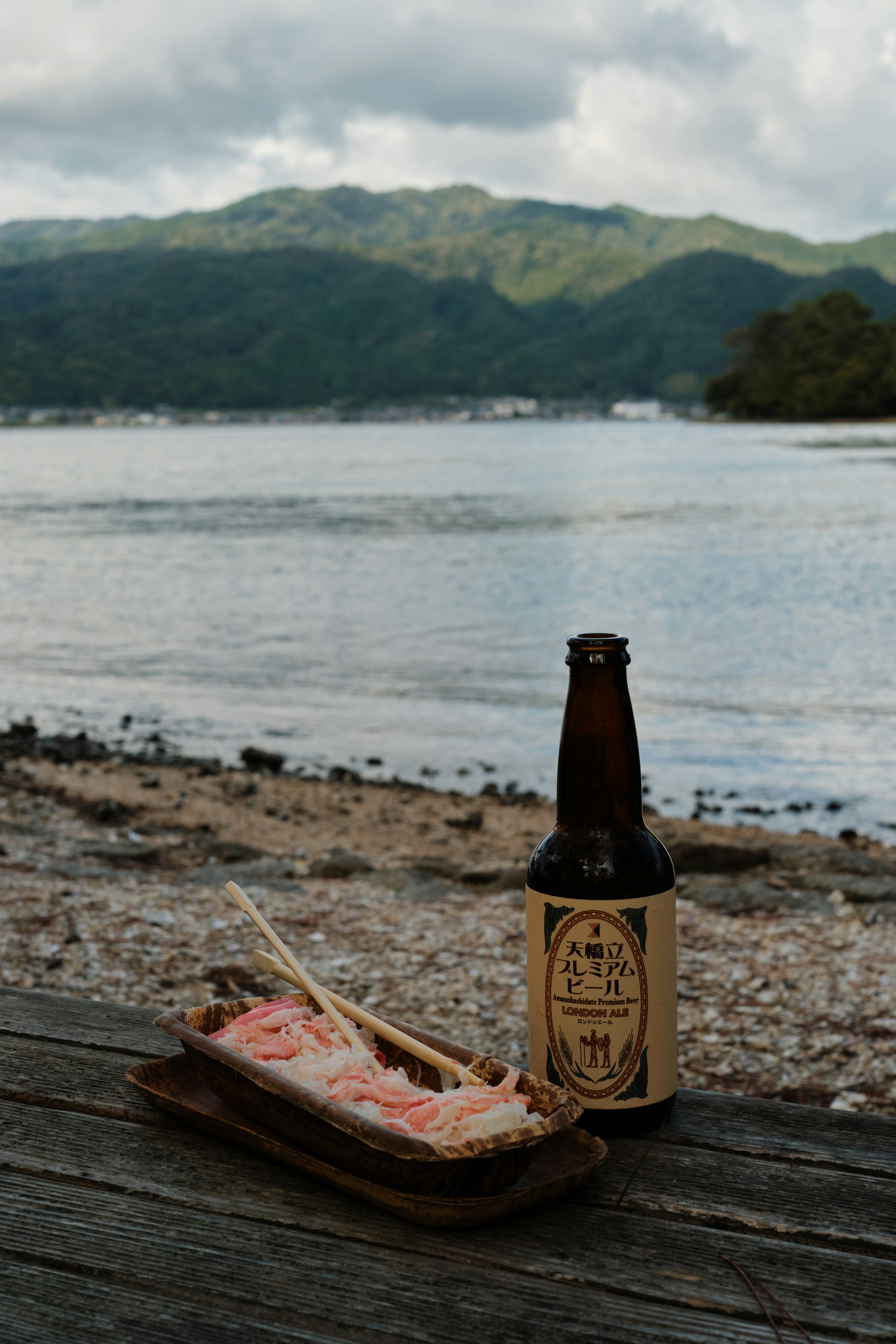 A bottle of beer sitting on top of a wooden table