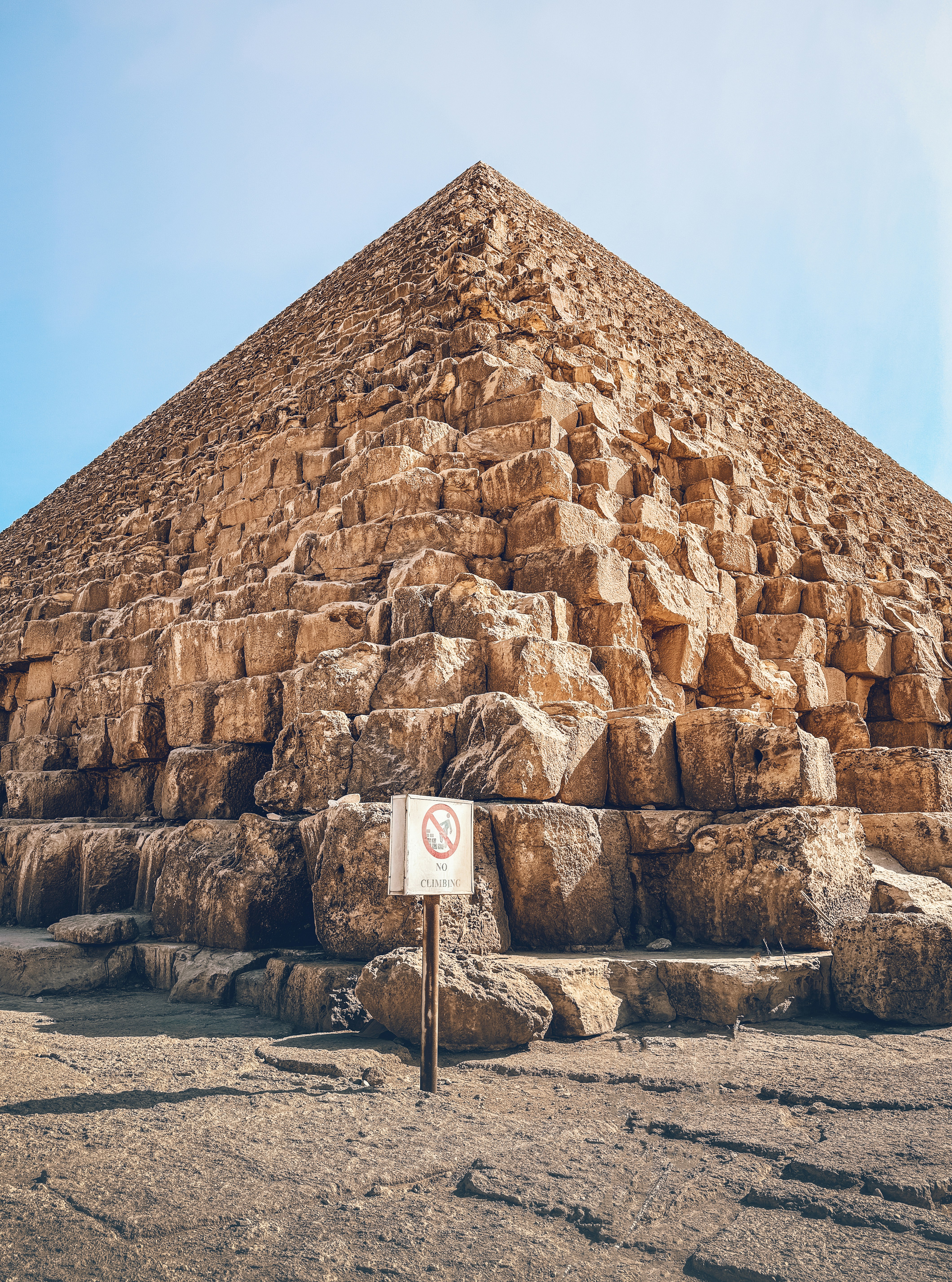 A very tall pyramid with a sign in front of it photo – Free Egypt Image ...