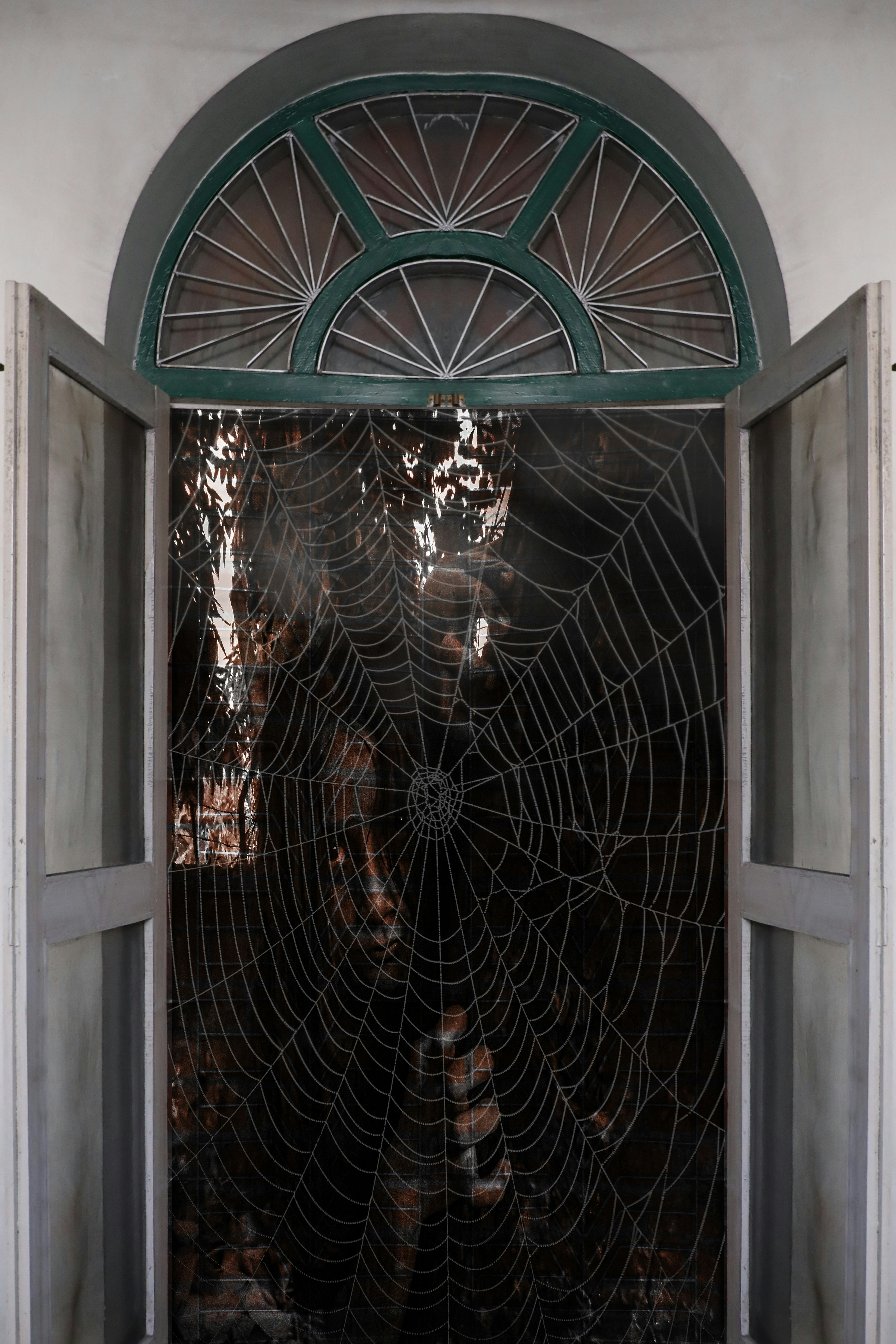 Spiderweb Threshold: Light Framing the Open Door