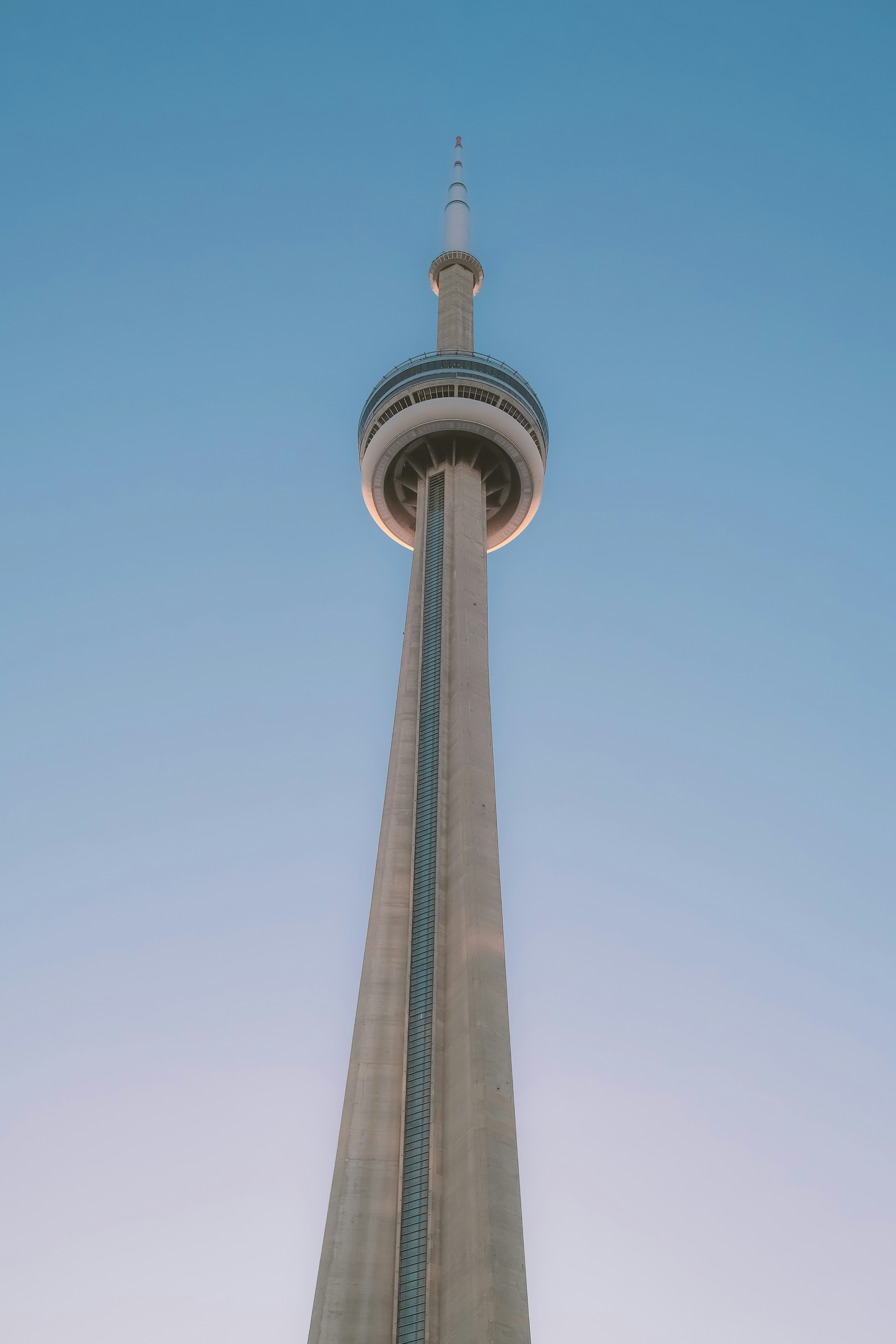 A tall tower with a clock on it's side photo – Free Cn tower Image on ...