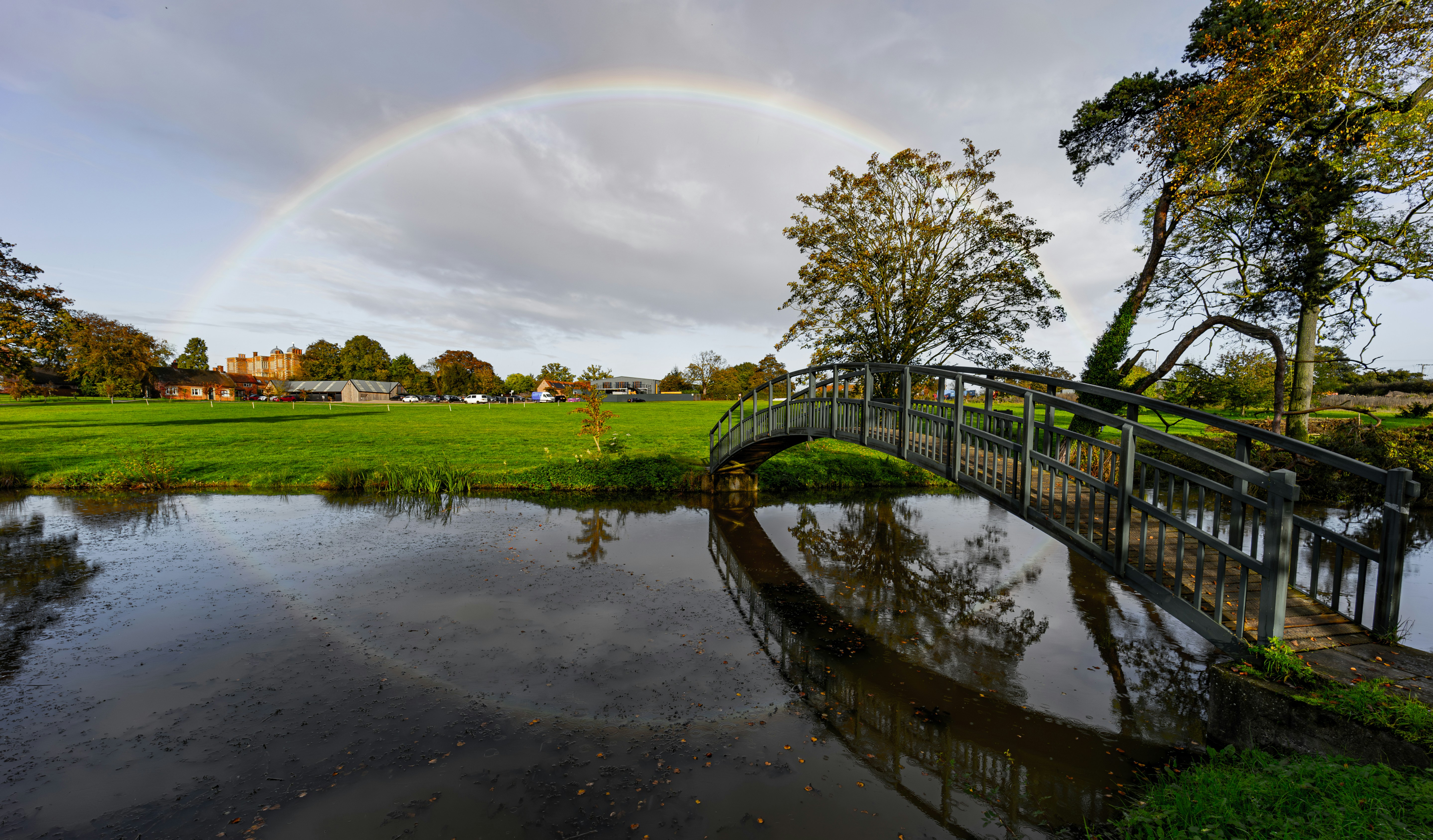 Rainbow Over the Arched Park Bridge, Reflected in a Tranquil Pond