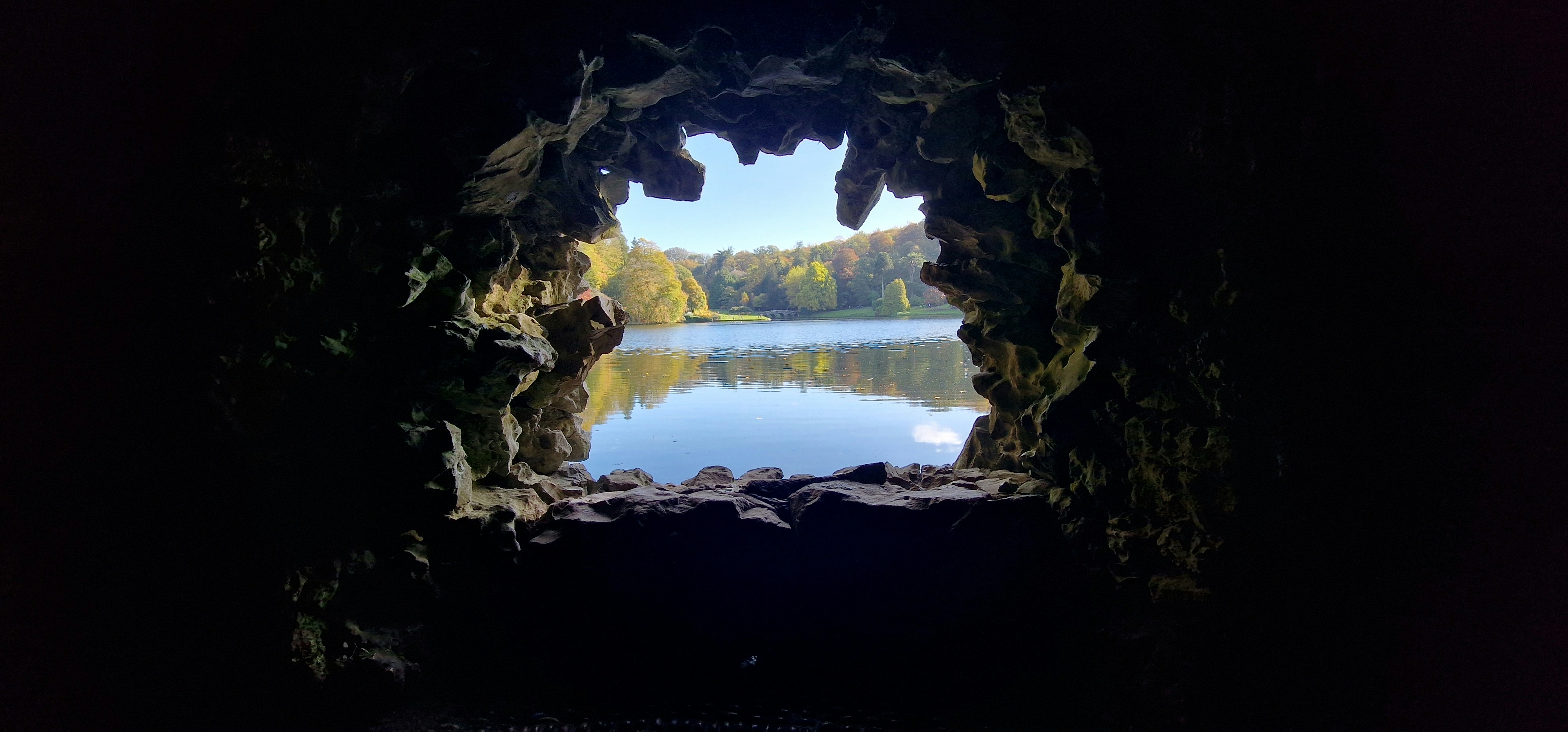Limned Vista: Lake Whisper Through a Cavern’s Mouth