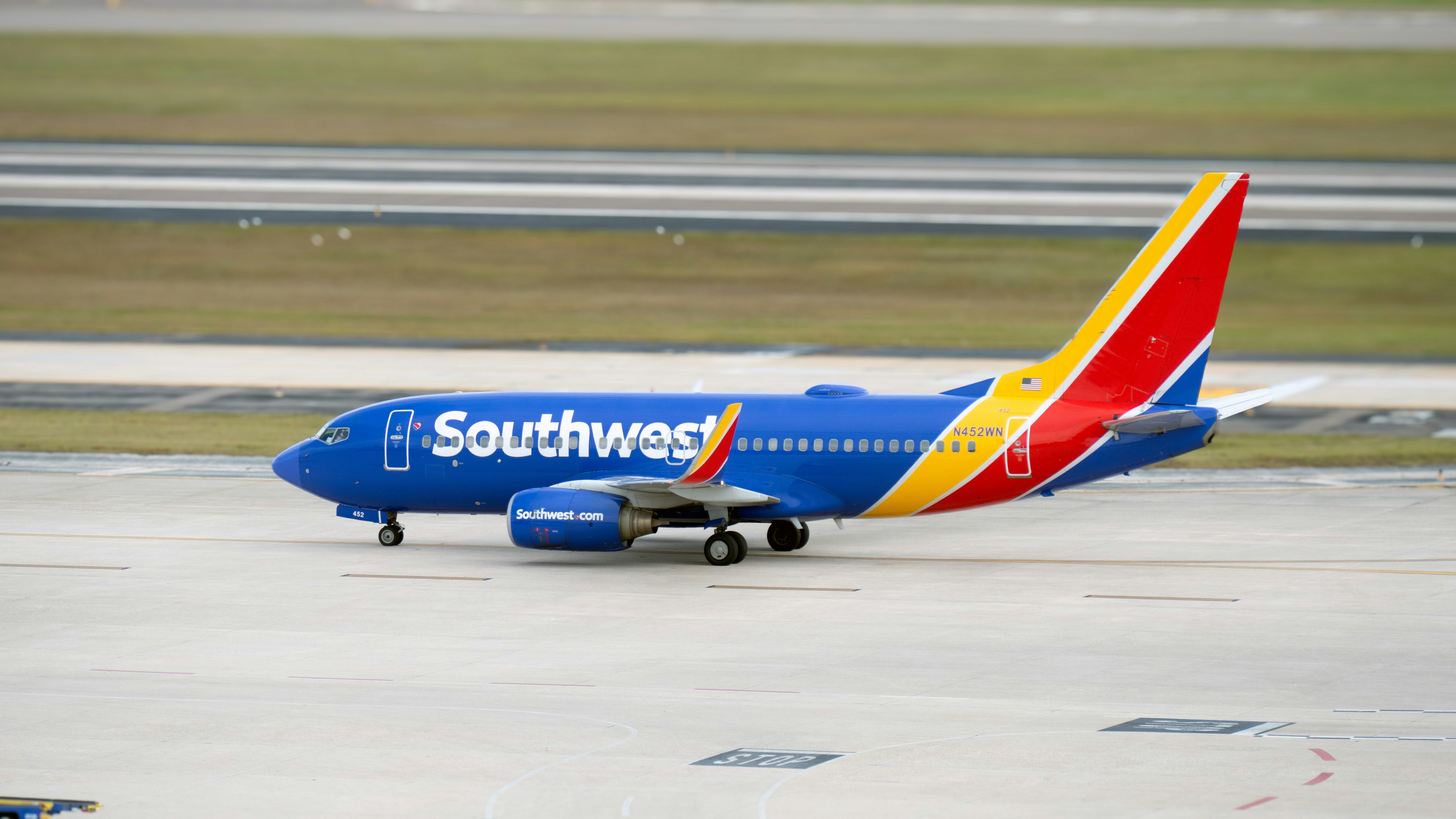 A southwest airlines plane on the runway at an airport photo – Free ...