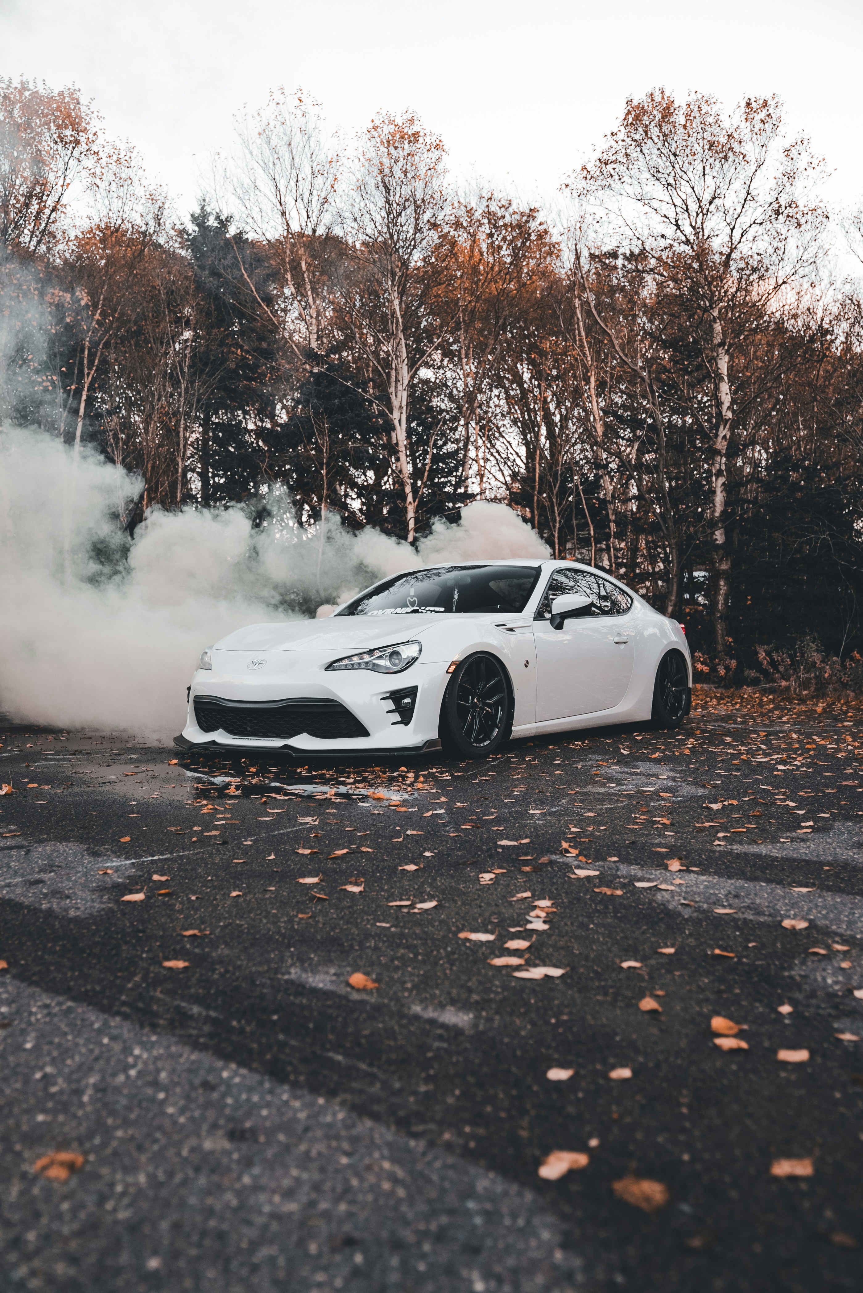 A white car with smoke coming out of it photo – Free Automobile Image ...