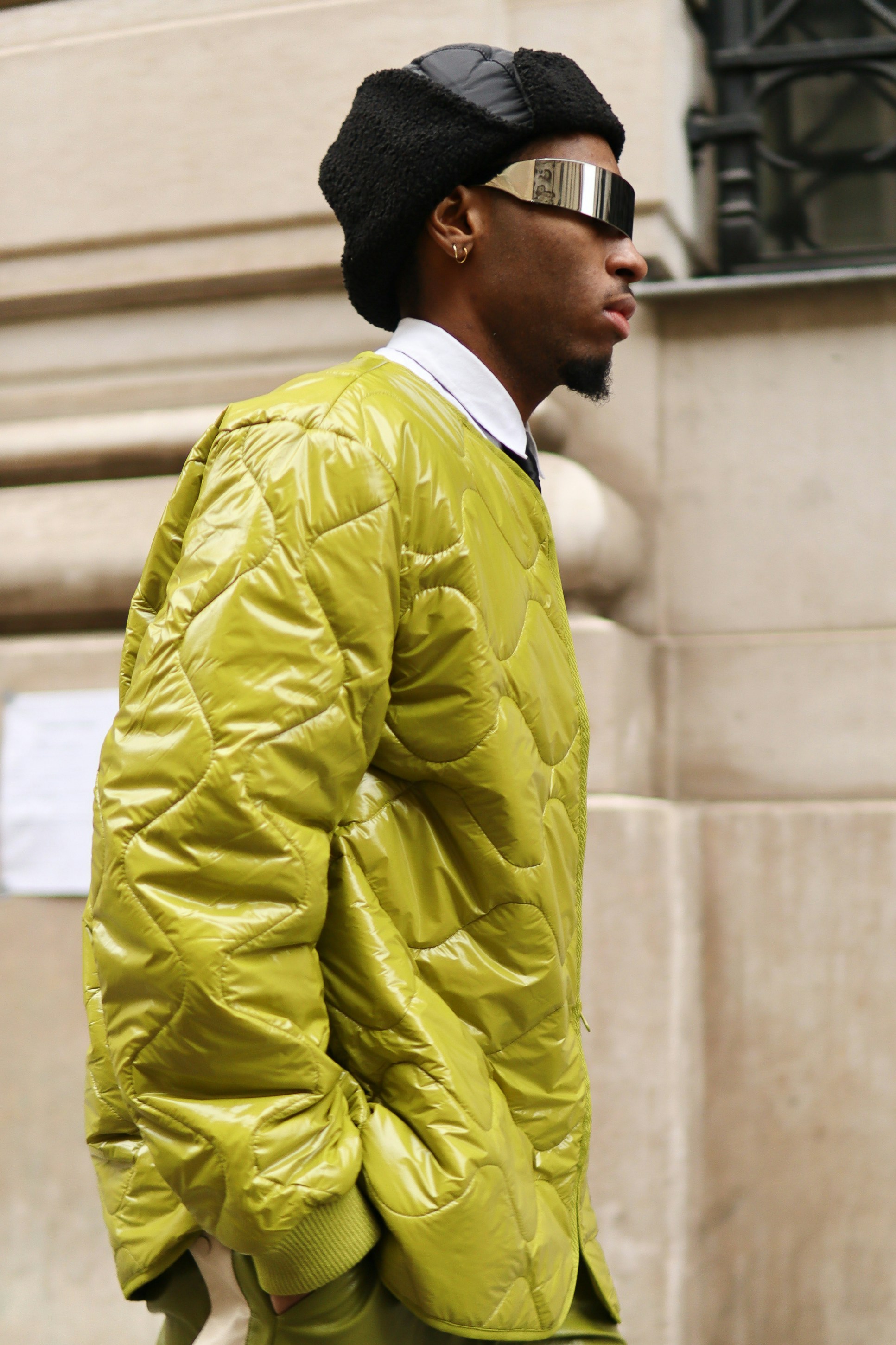 Neon-lime jacket silhouette under stone city glow
