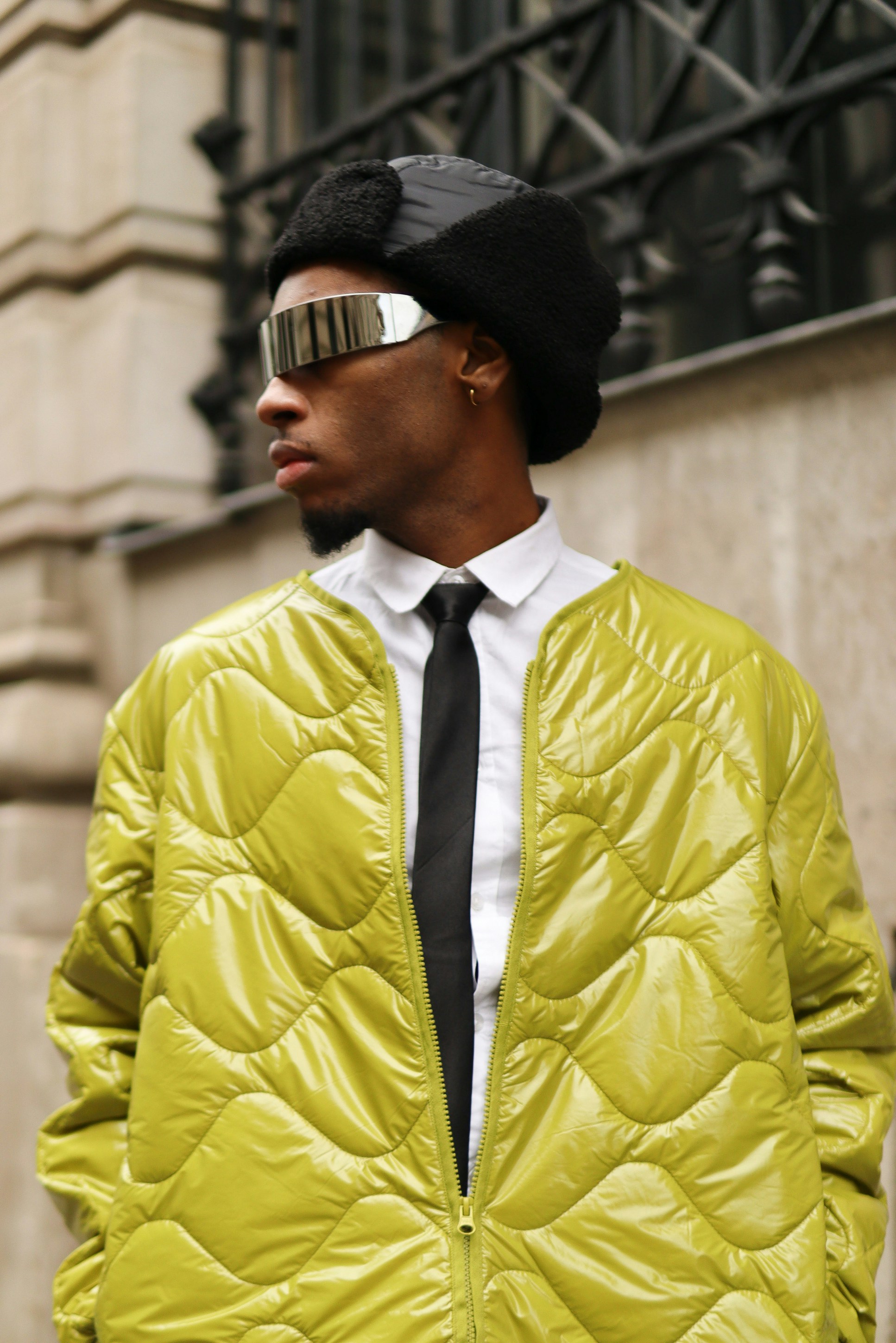 Lime Quilted Jacket Meets Futuristic Visor in an Urban Portrait