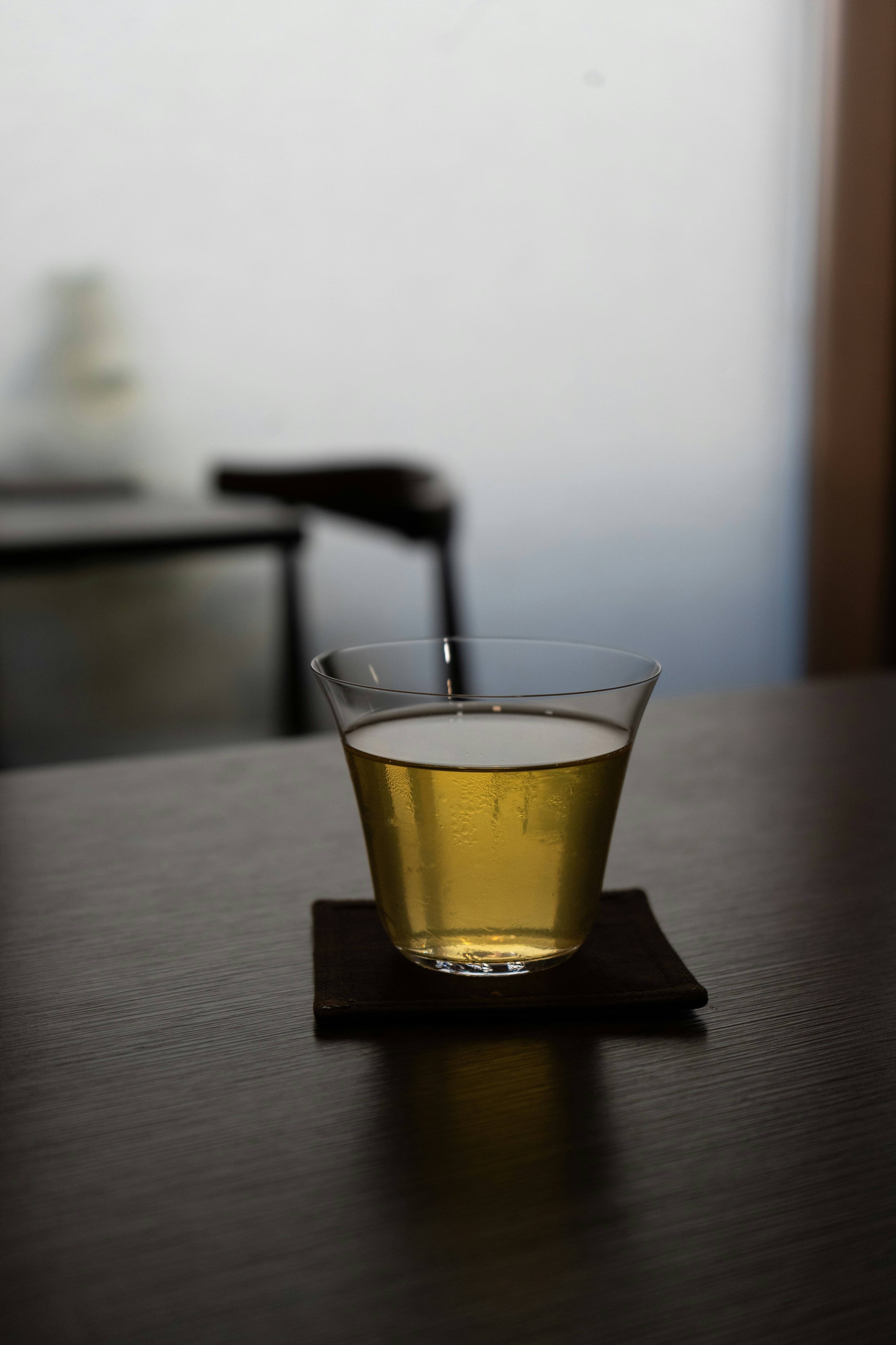 Amber Solo: Quiet Focus on a Glass of Beer in Soft Lighting