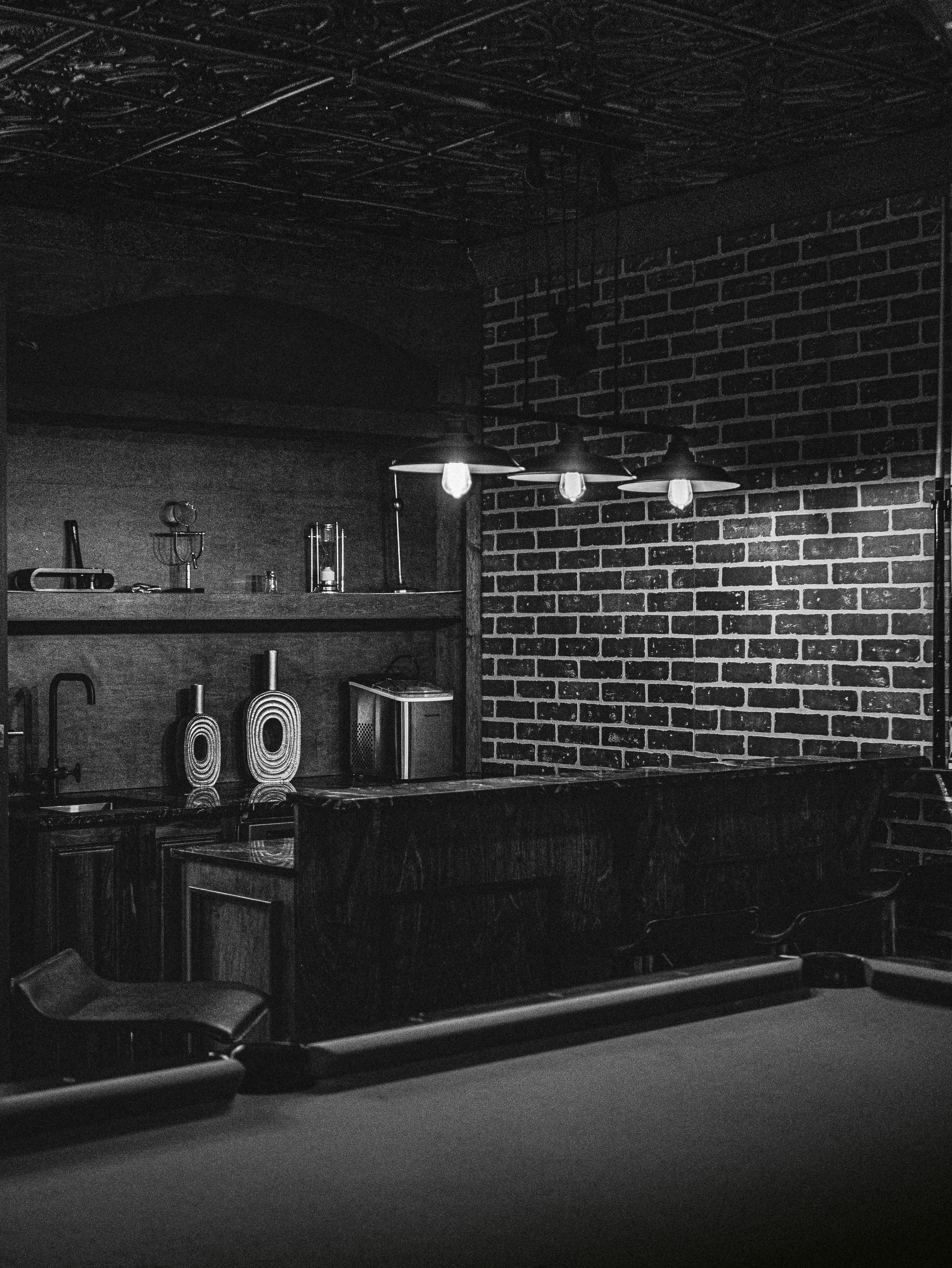 Noir Barroom: Soft Pendant Glow Over Brick and Pool Table