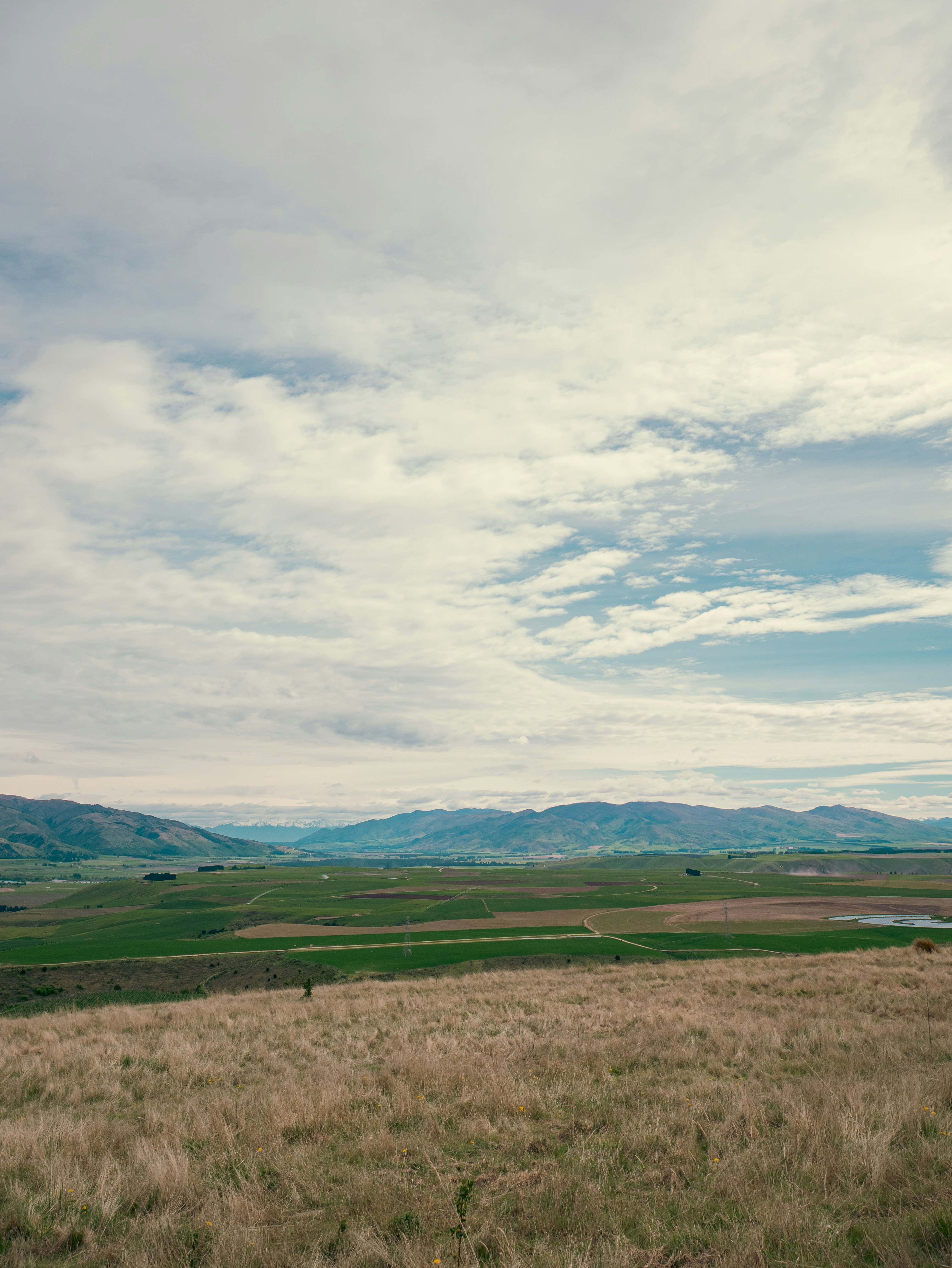 A large open field with mountains in the distance photo – Free ...