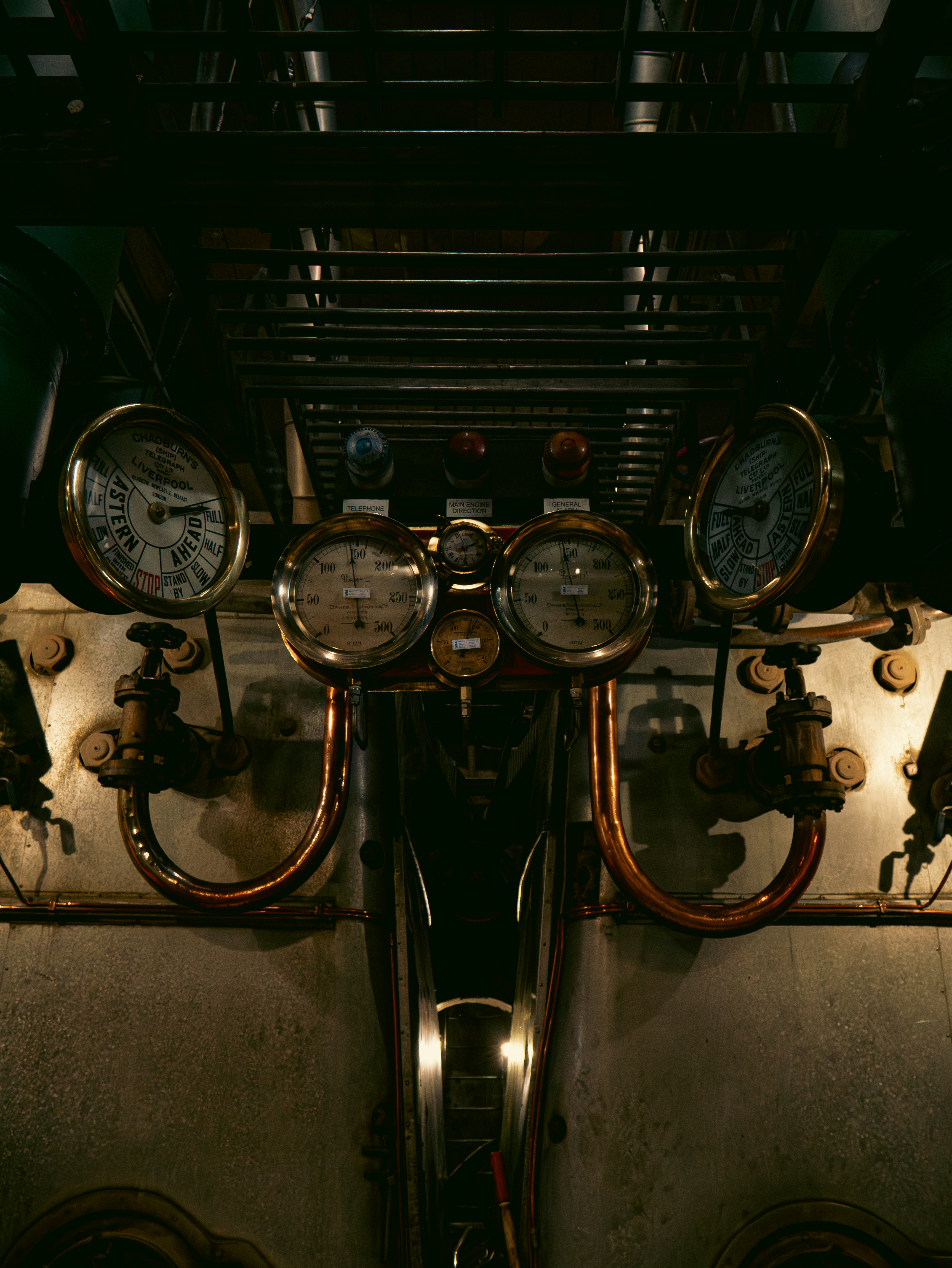 Dimly Lit Gauge Cluster: Copper Pipes and Analog Dials in a Steam-Driven Control Panel