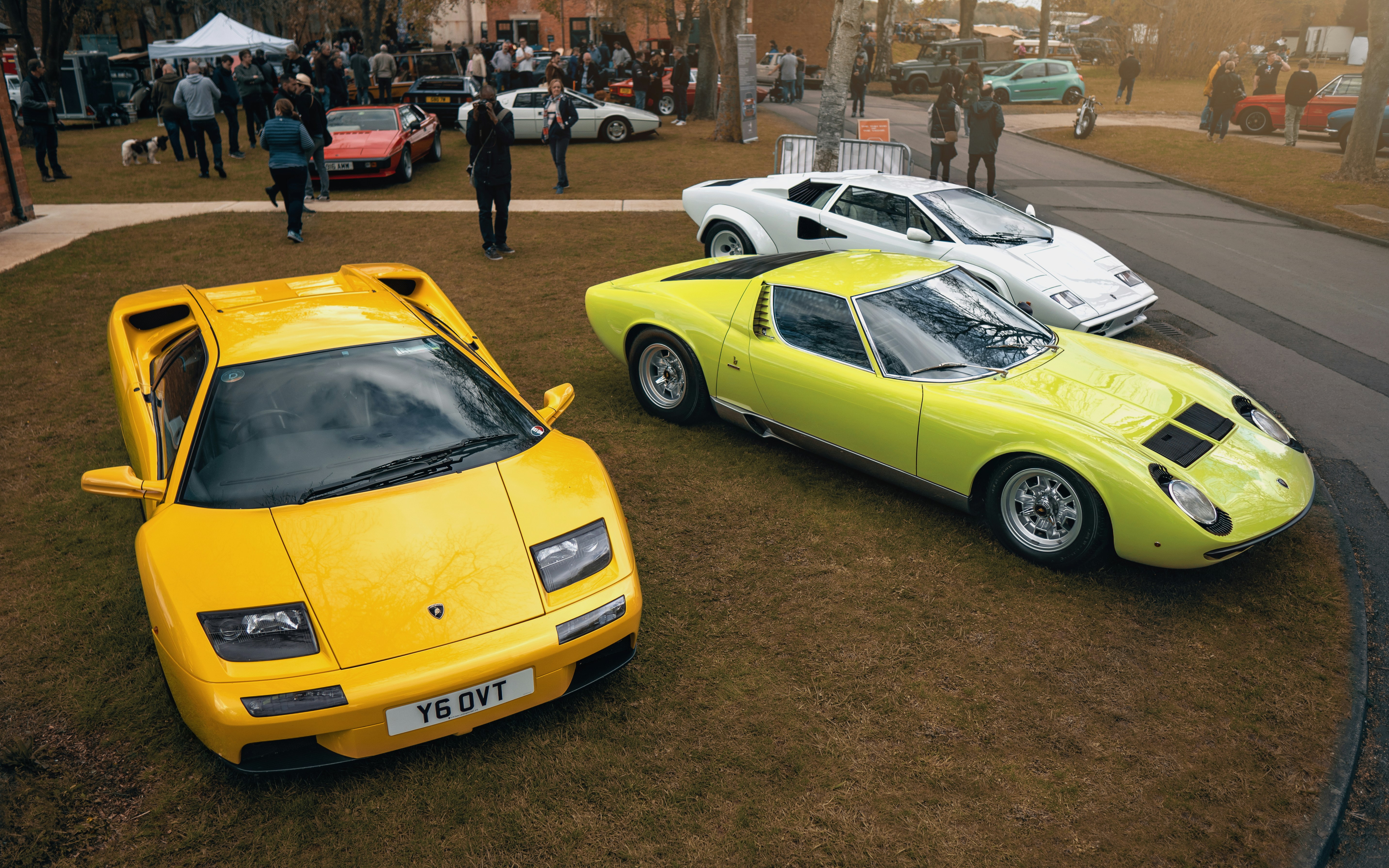 A group of three sports cars parked next to each other photo – Free ...