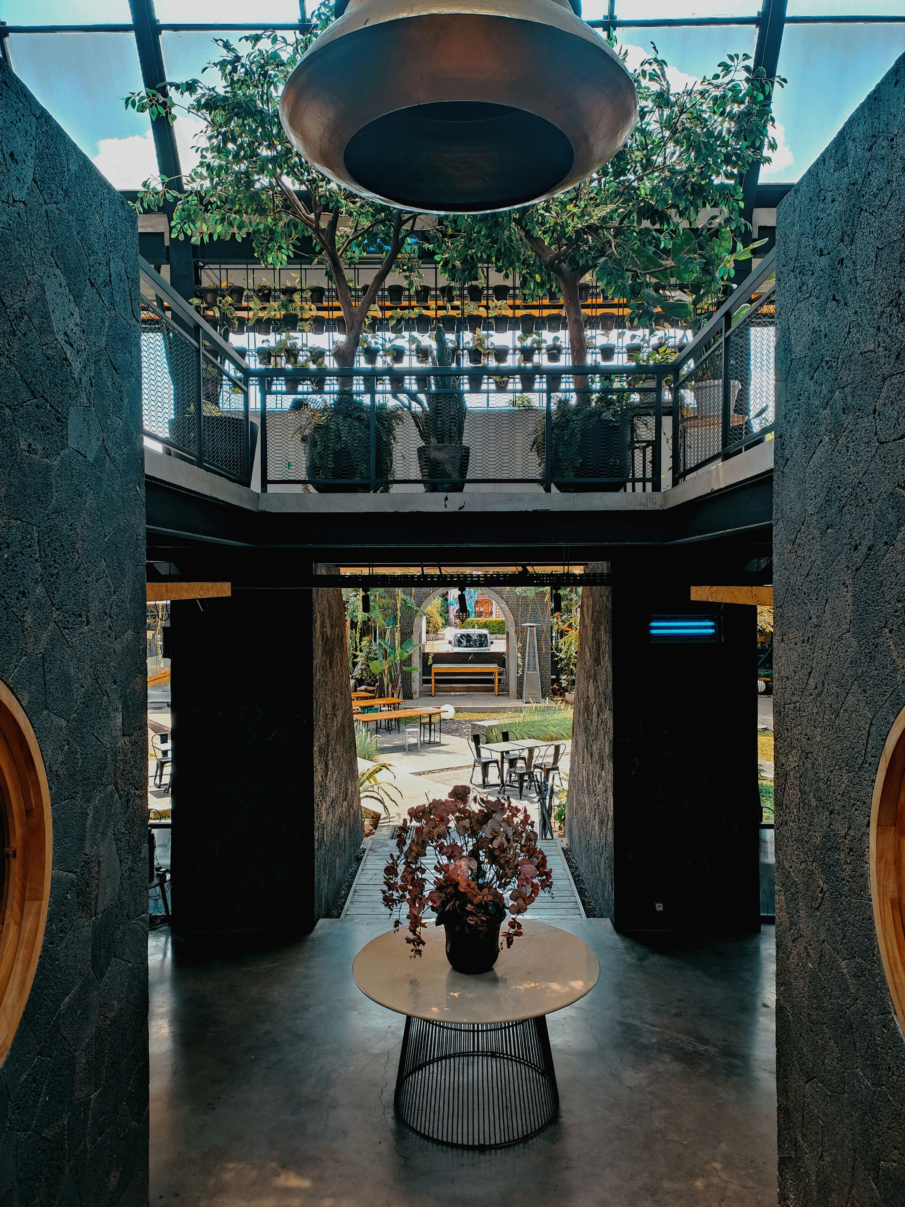 Tabletop Bloom Framing a Courtyard Through Stone Arches