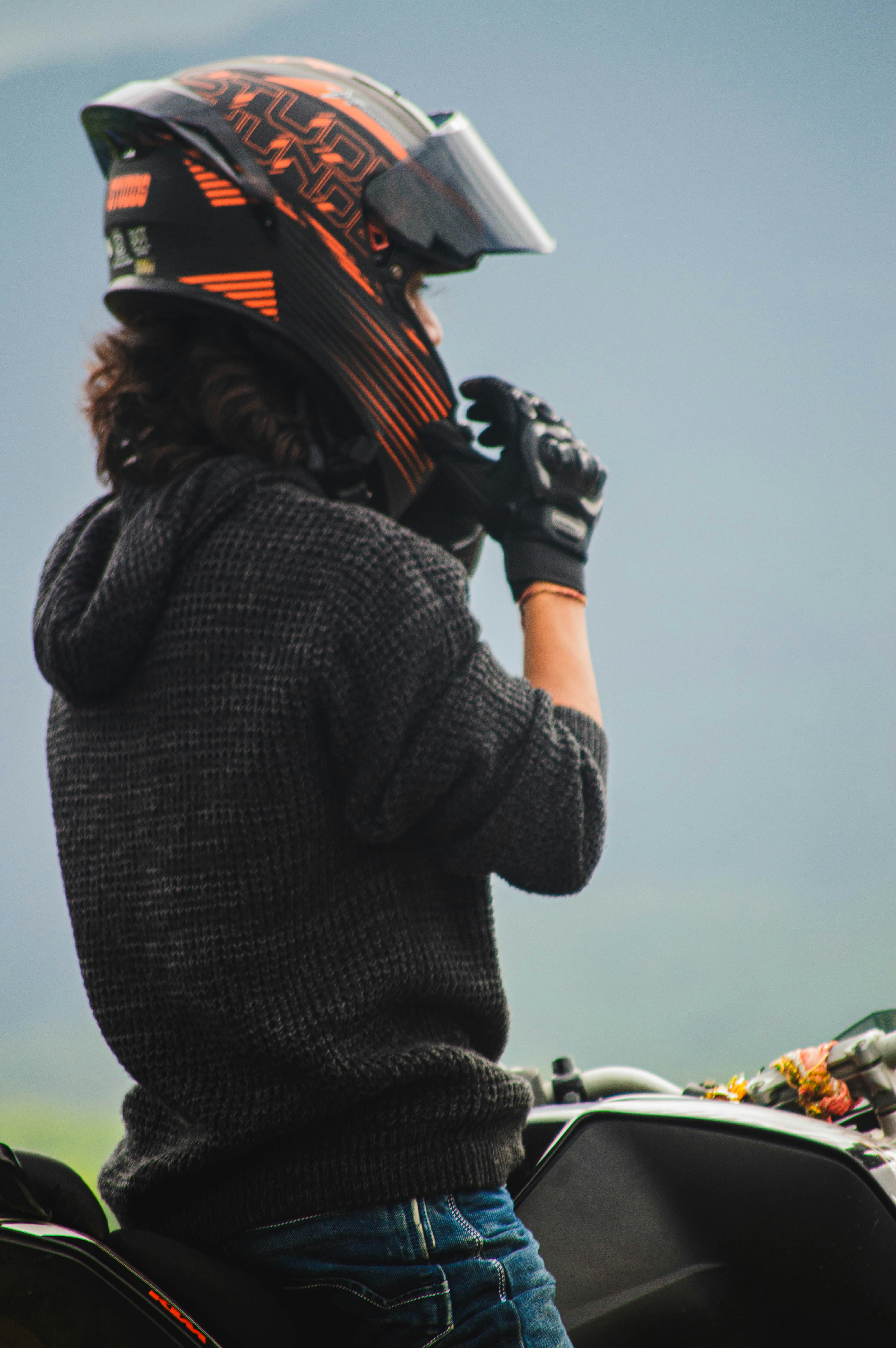 Neon Visor, Quiet Stance: A Rider Pauses by the Motorcycle