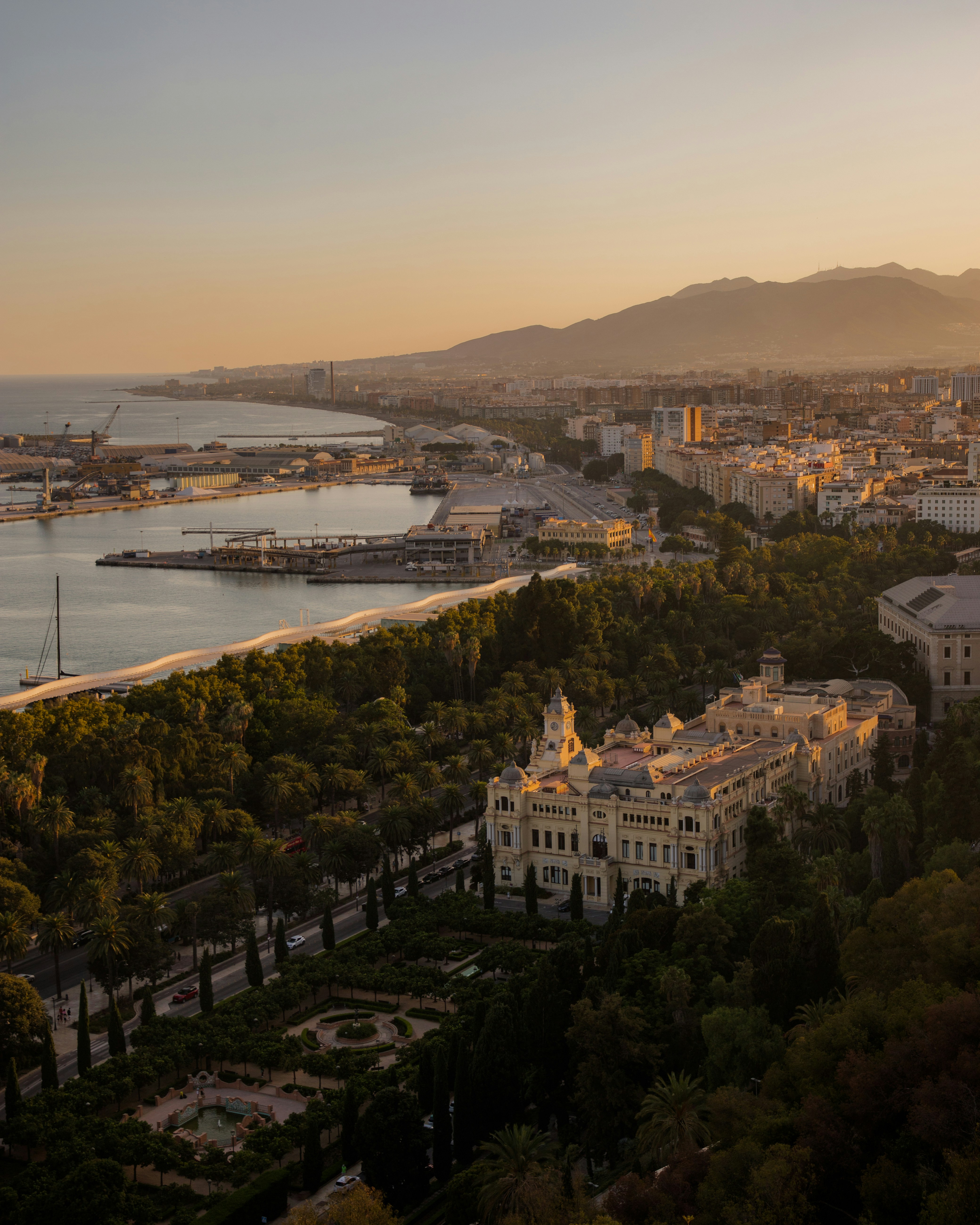 Golden Hour Over the Bay: Palm-Lined Promenade and a Beaux-Arts Villa