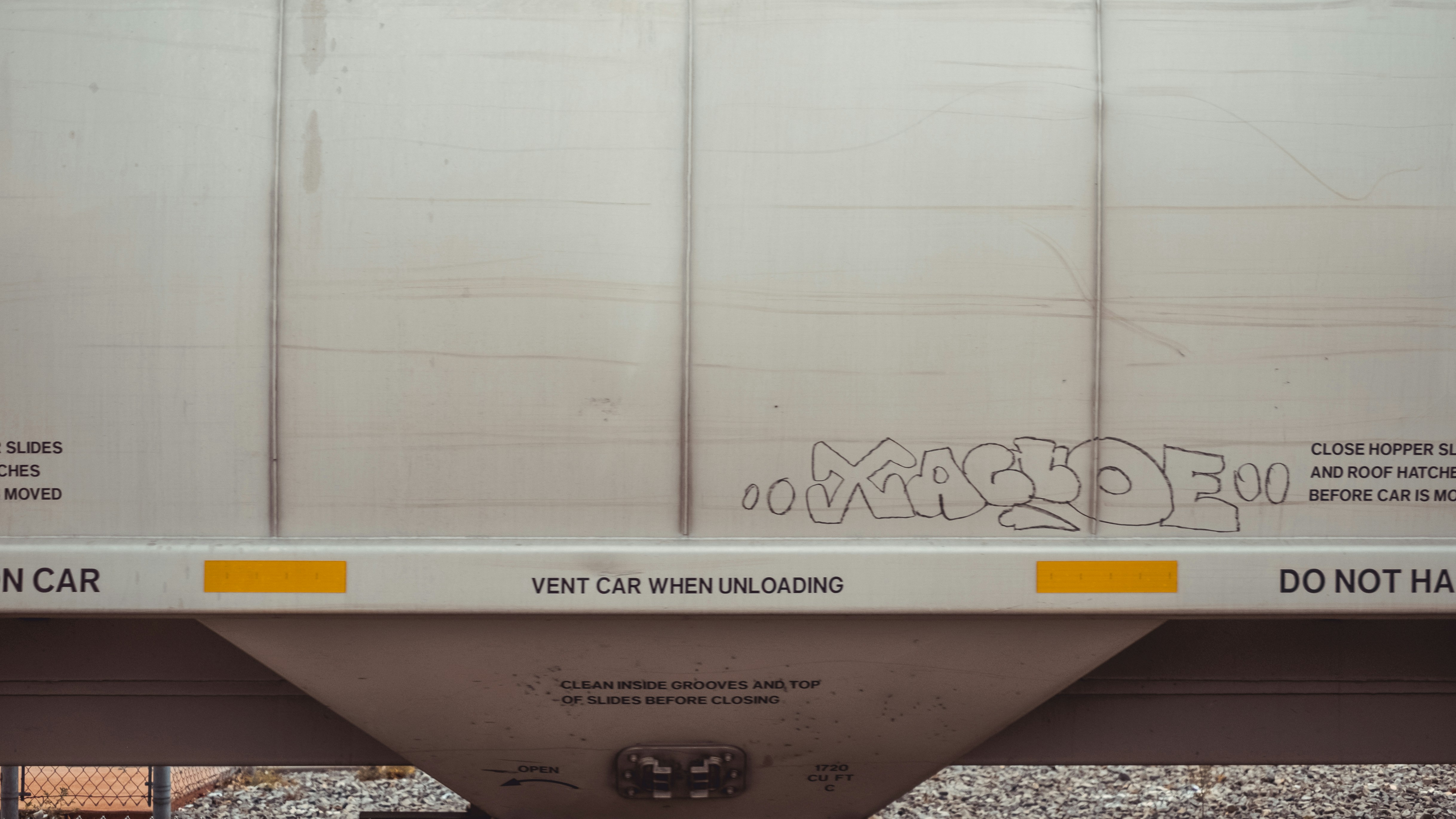 Tag on Steel: Graffiti Adorns a Freight Trailer in Daylight