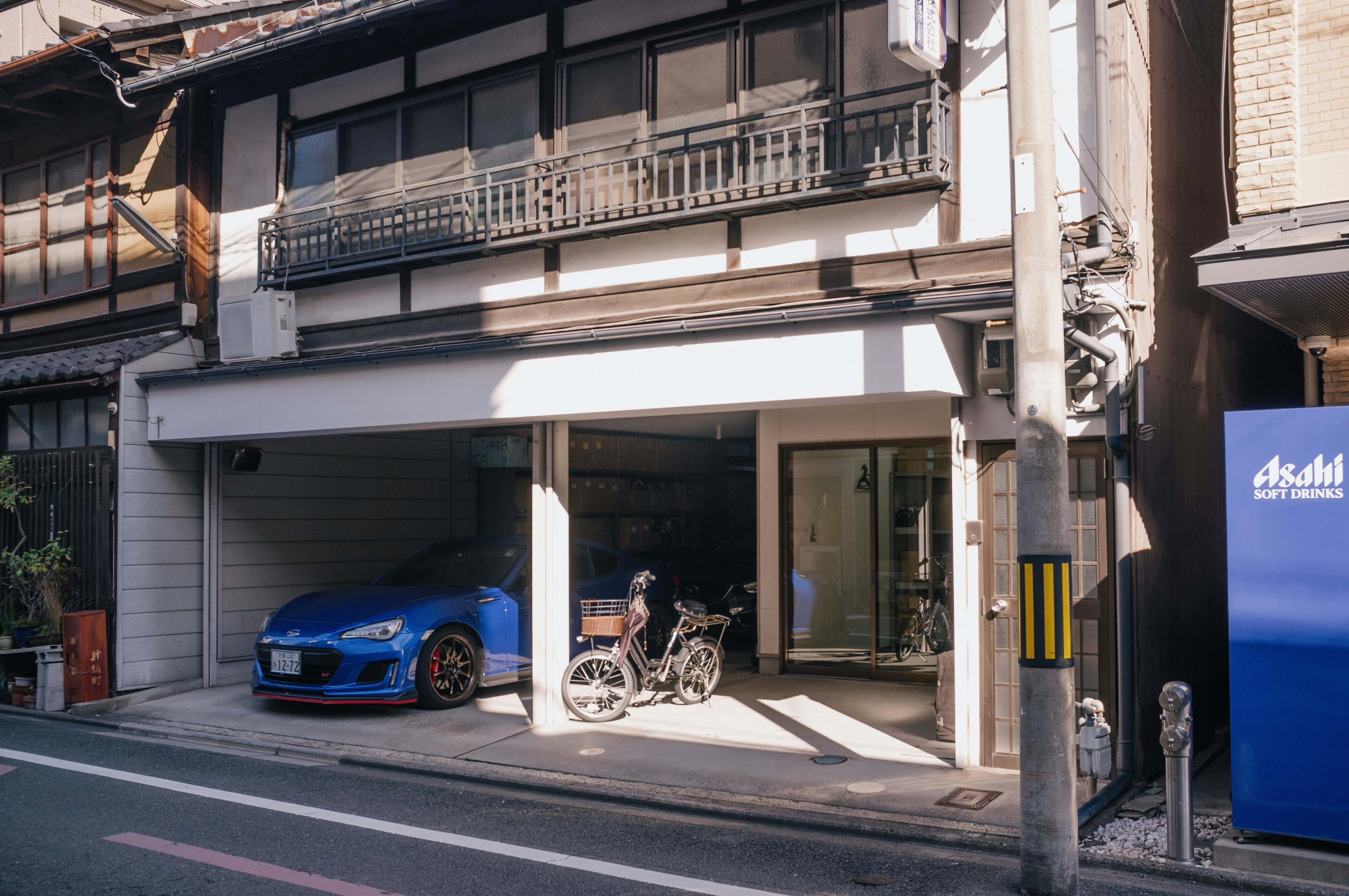 Blue sedan in a sunlit storefront showroom