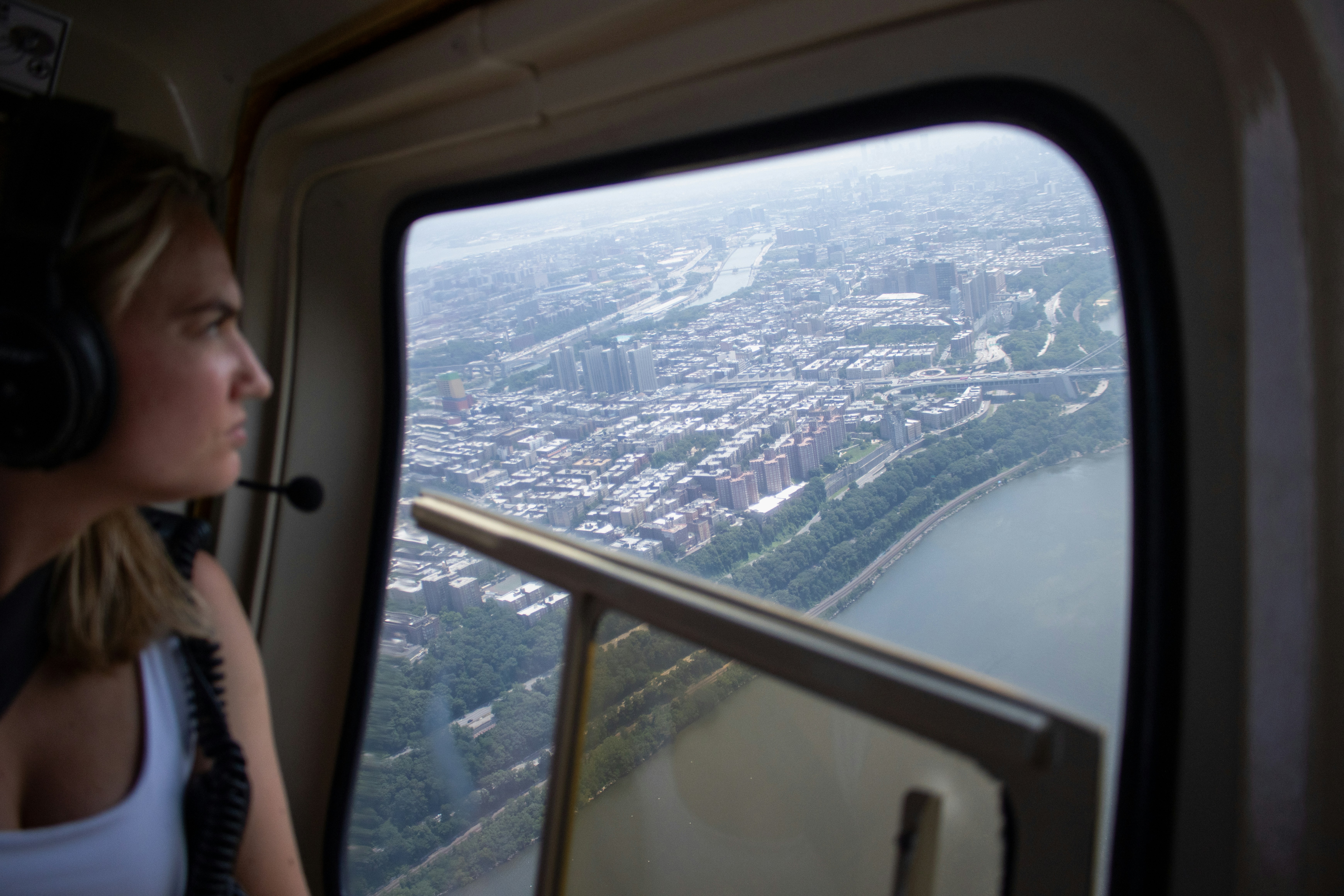 A woman sitting in an airplane looking out the window photo – Free New ...