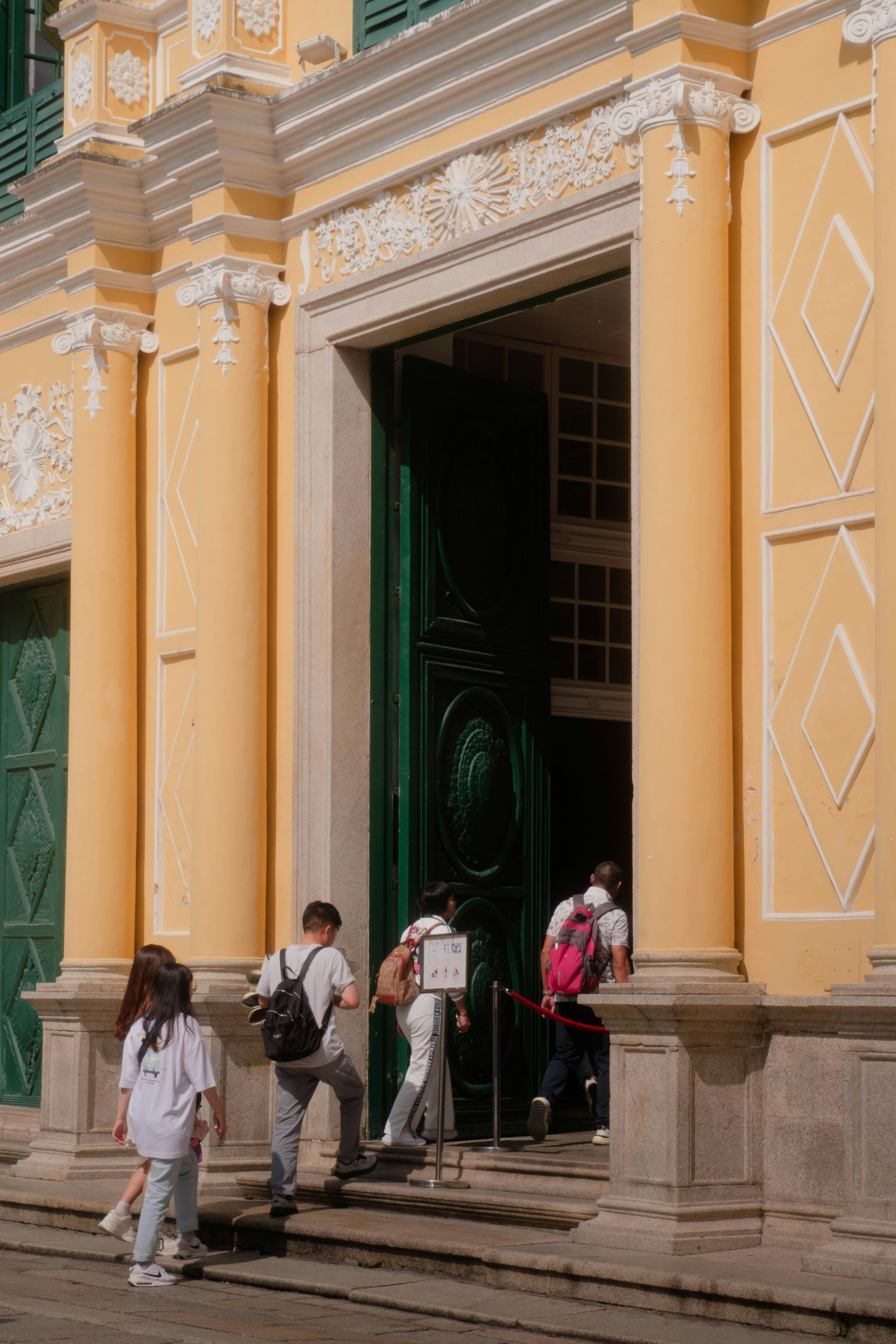 A group of people standing outside of a building photo – Free Macau ...