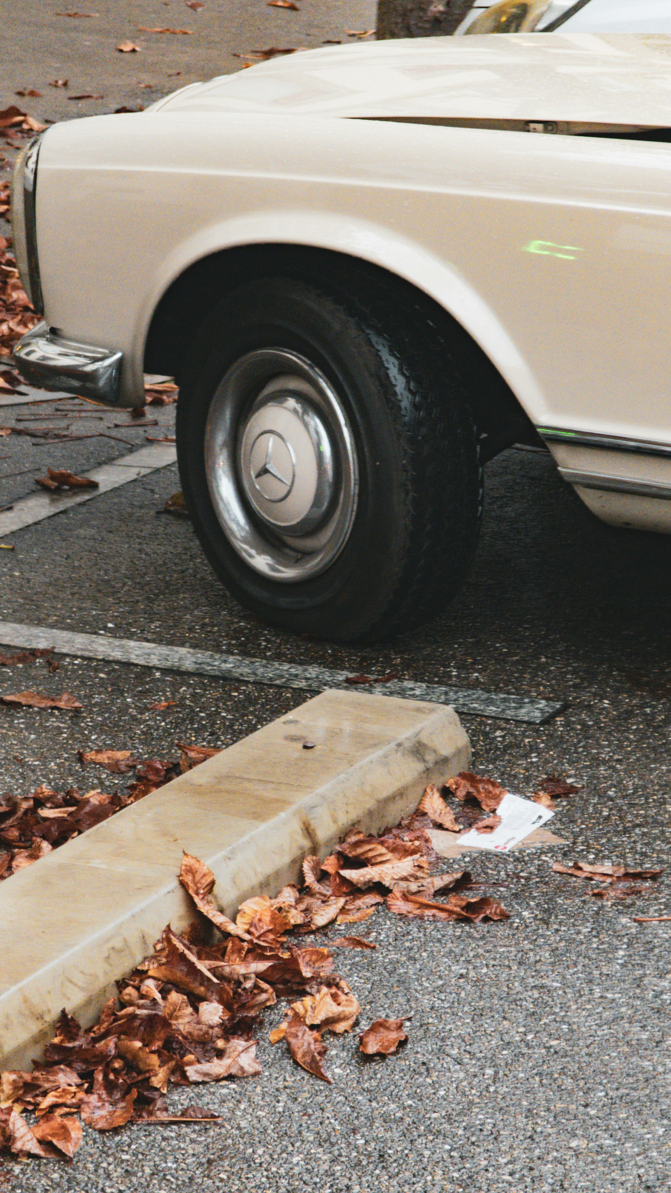 A white car parked on the side of the road