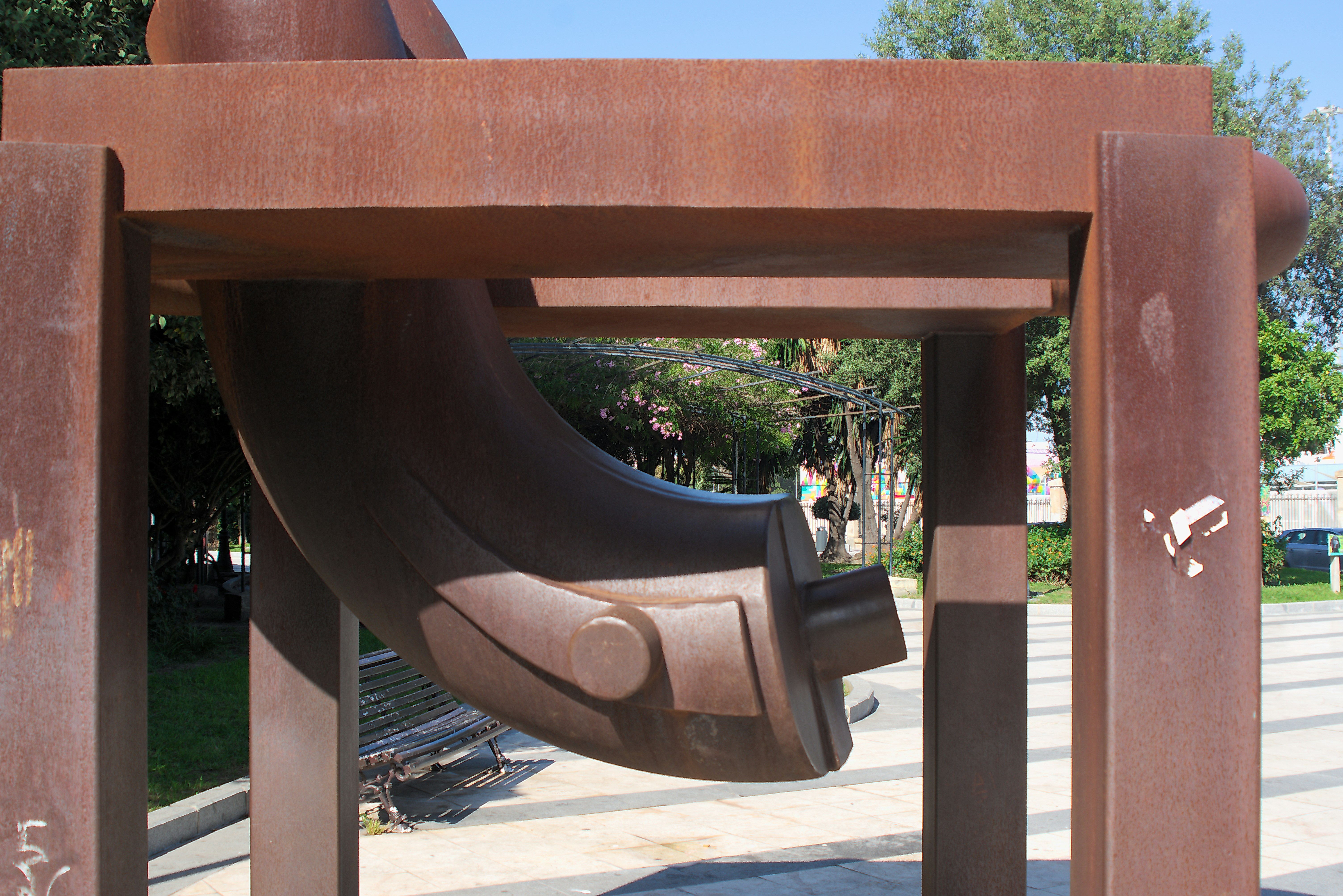 Rusty Arch Framed by Steel: The Park Sculpture's Hidden Curve