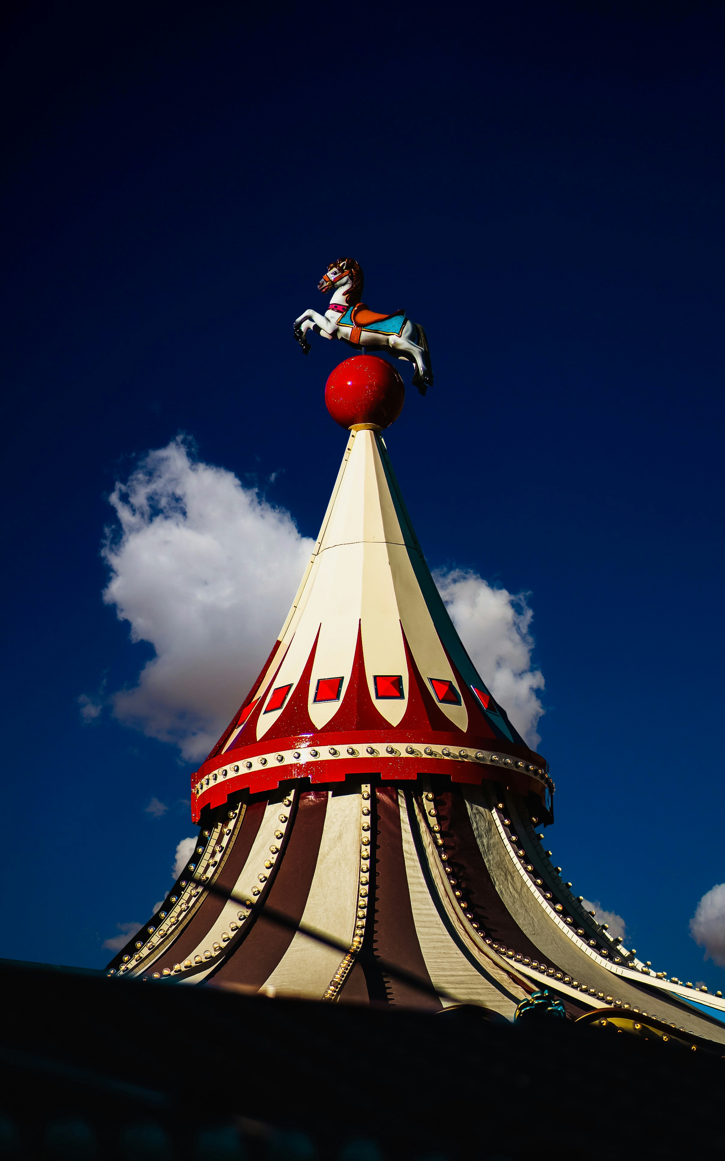 Horse on the Spire: A Vintage Carousel Peak Under a Cerulean Sky