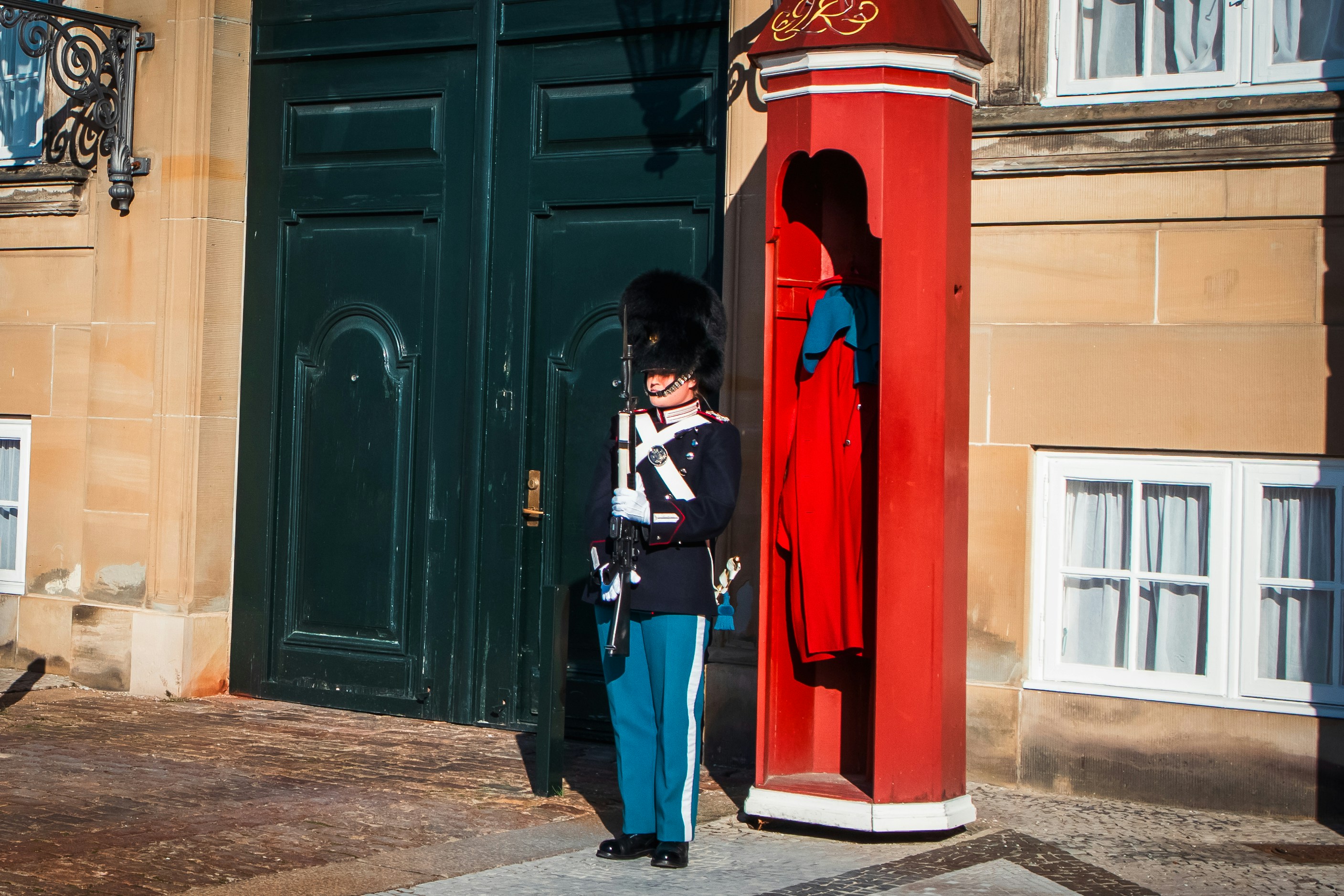Guard with Blue Trousers at the Red Booth