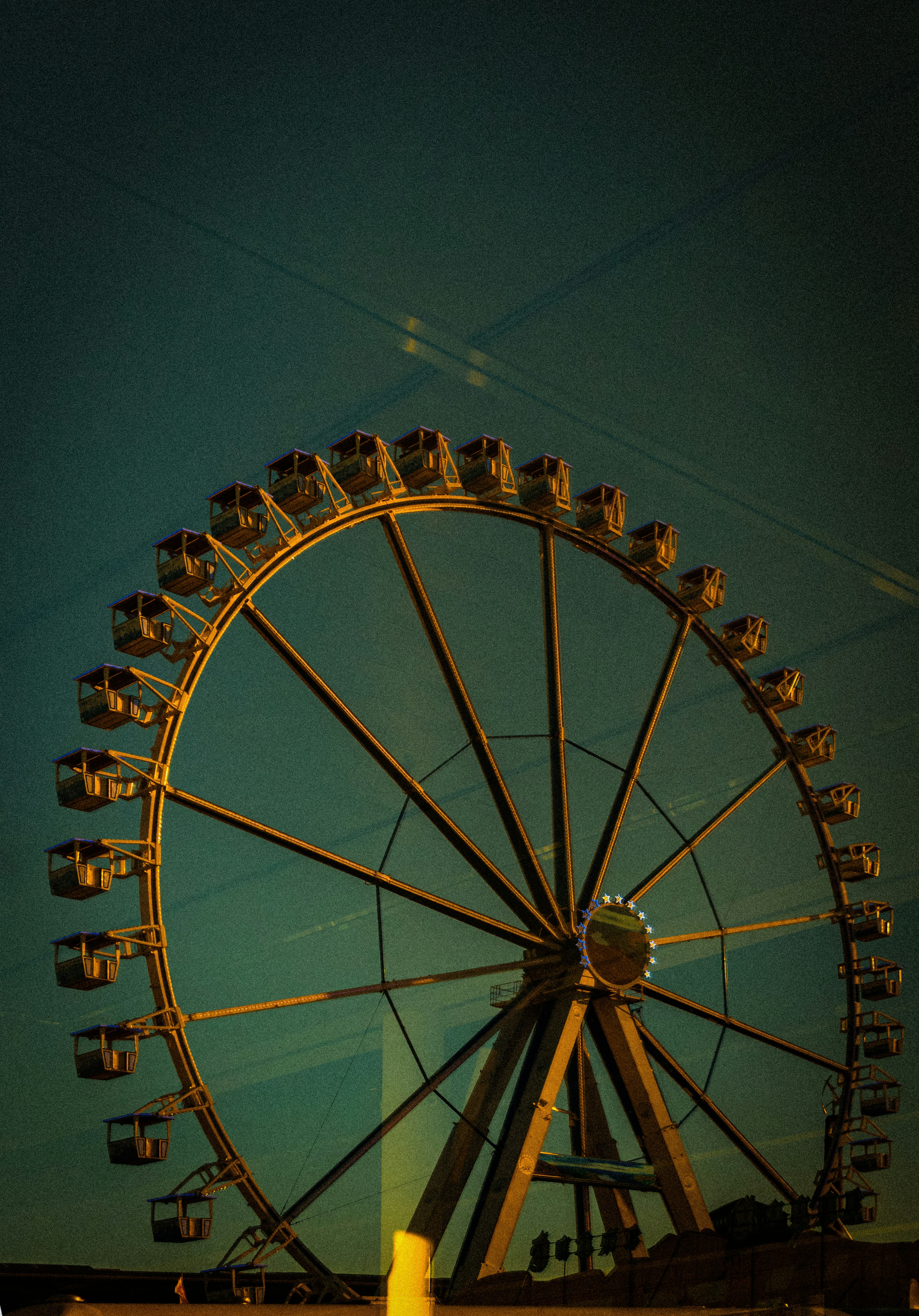 Teal Neon Ferris Wheel Circles the Night Sky