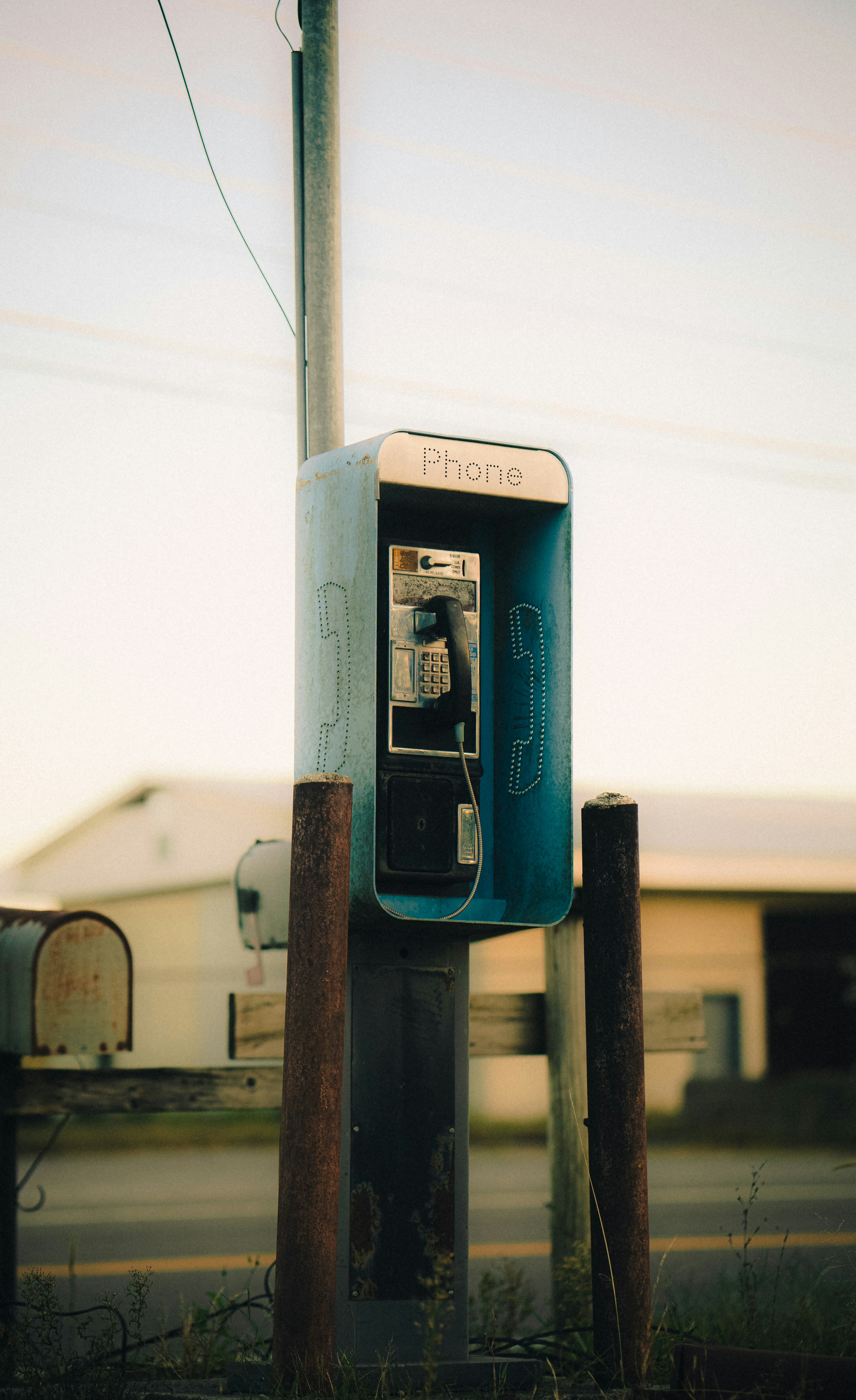 A telephone booth sitting on the side of a road photo – Free Phone ...