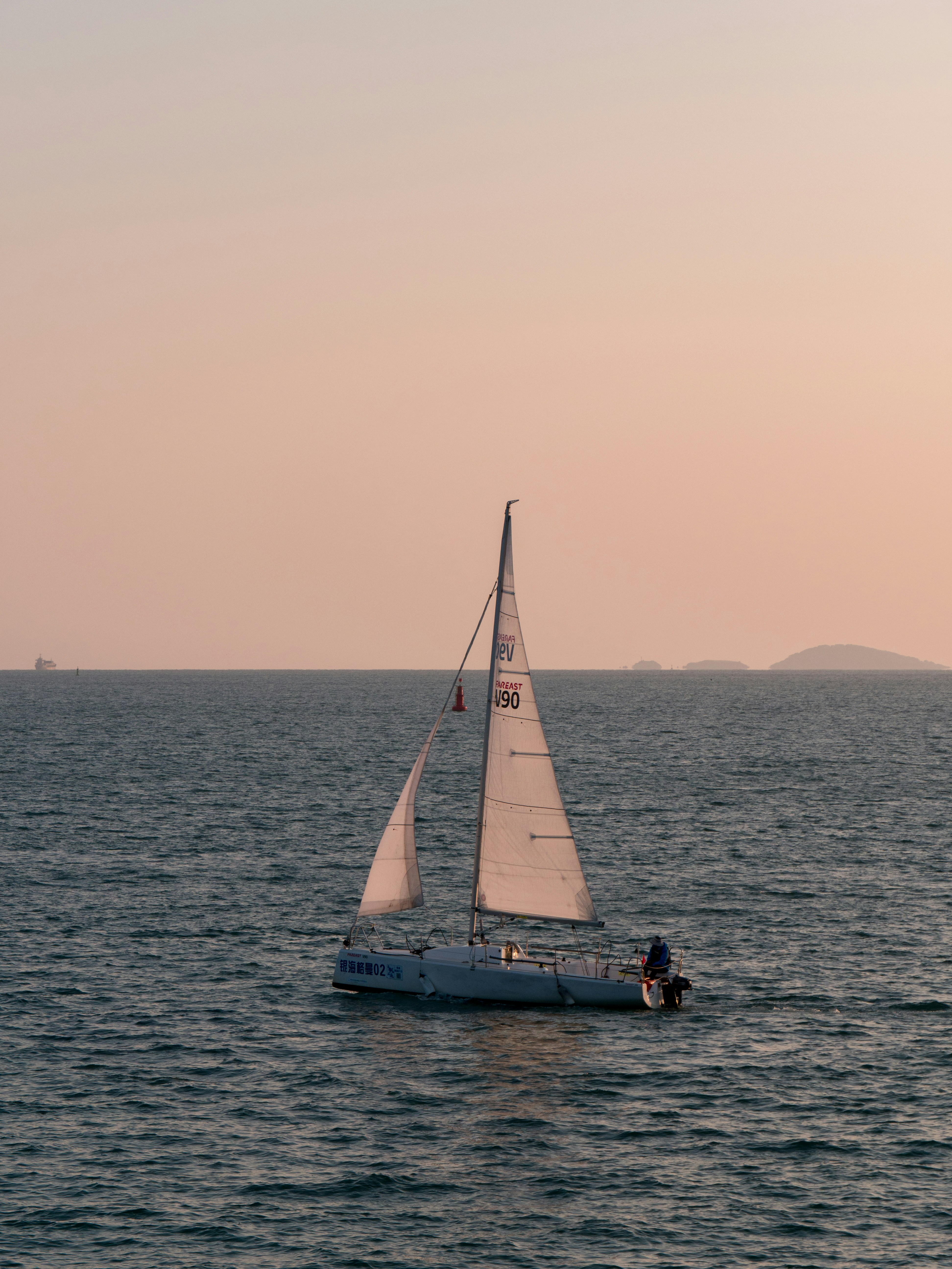 A sailboat sailing in the middle of the ocean