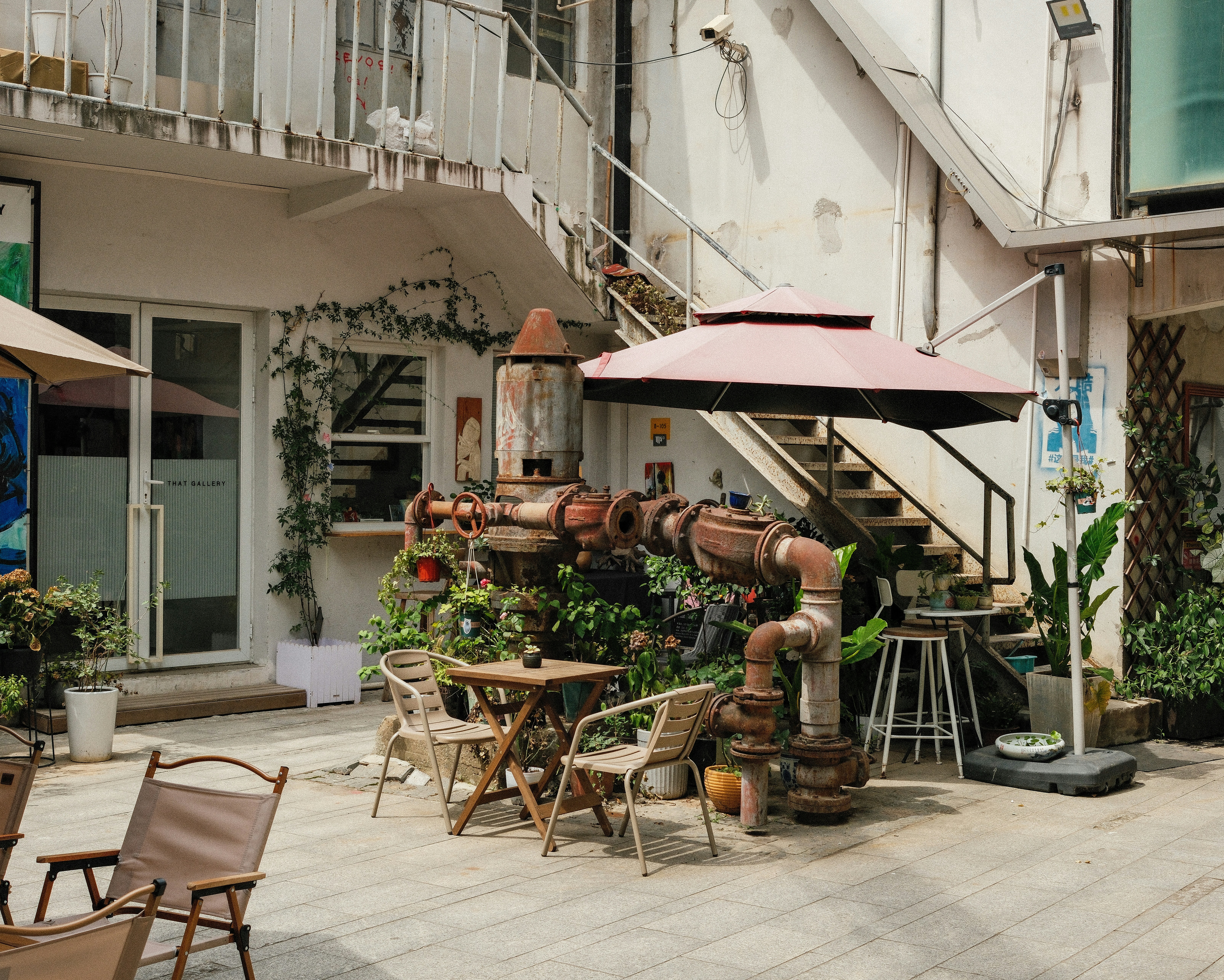 A group of tables and chairs outside of a buildingDhiemas Afif Febriyan