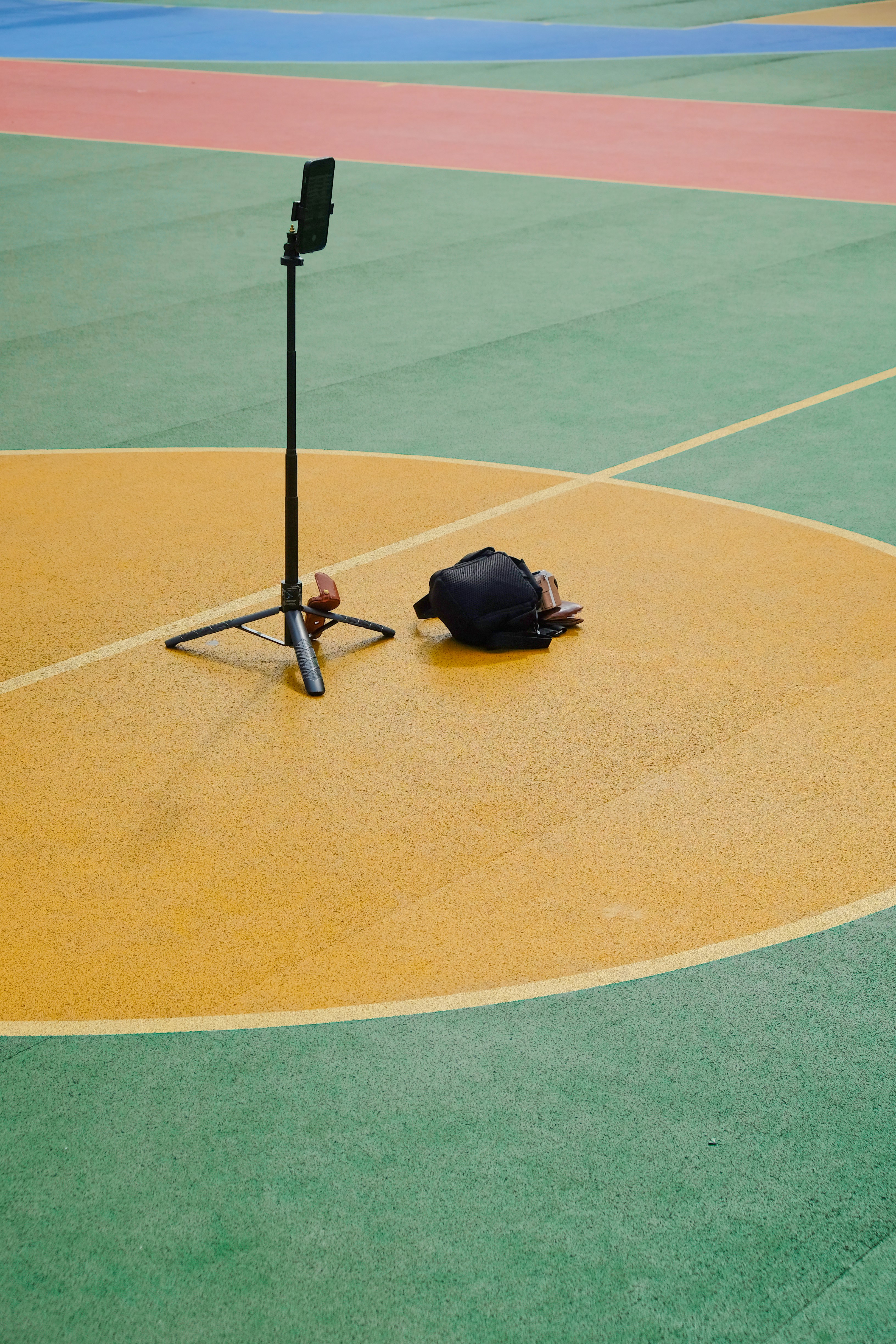 Pastel Court Studio: Tripod, Backpack, and a Quiet Scene