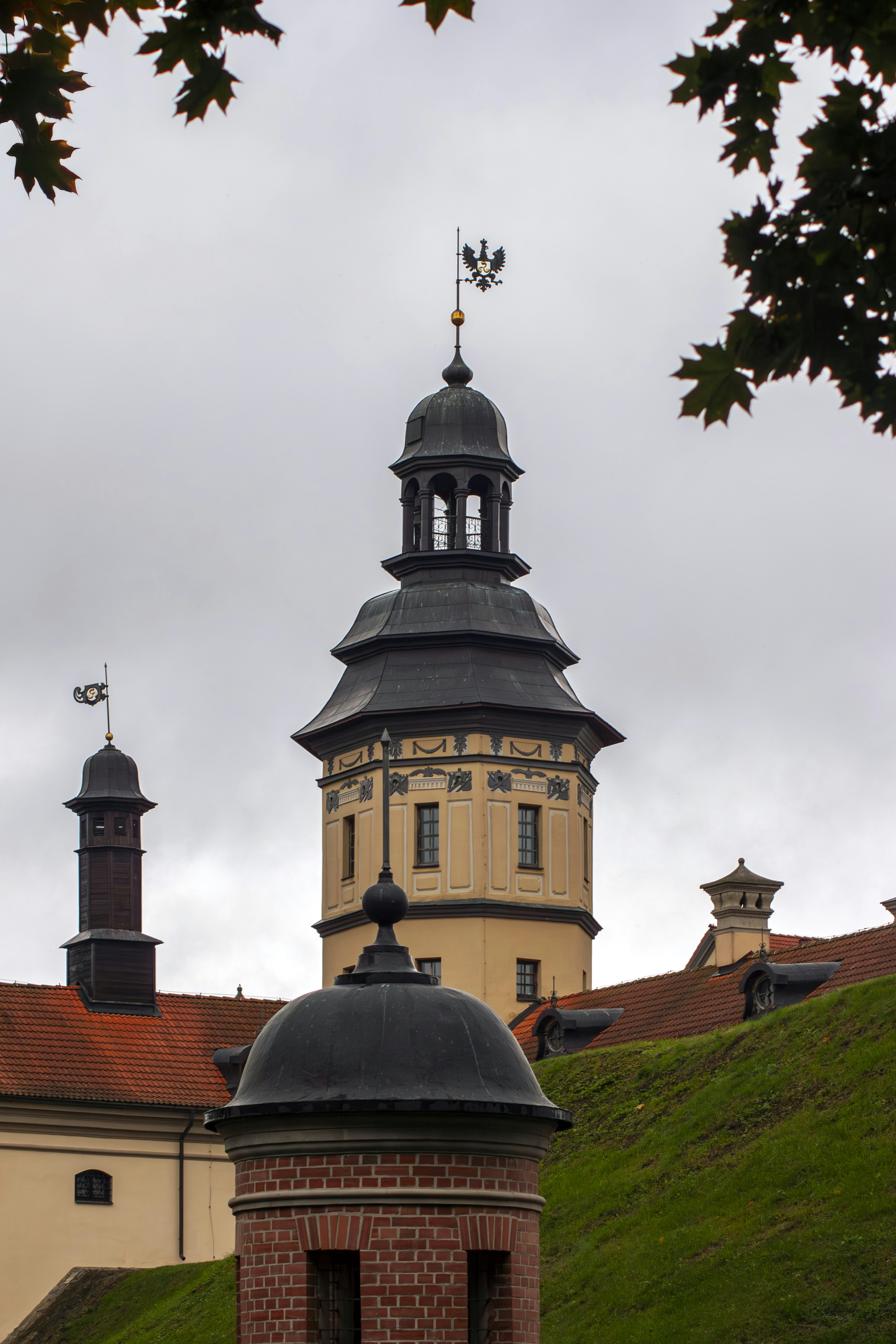 Tiered Baroque Tower Piercing the Cloudy Sky Above a Castle Courtyard