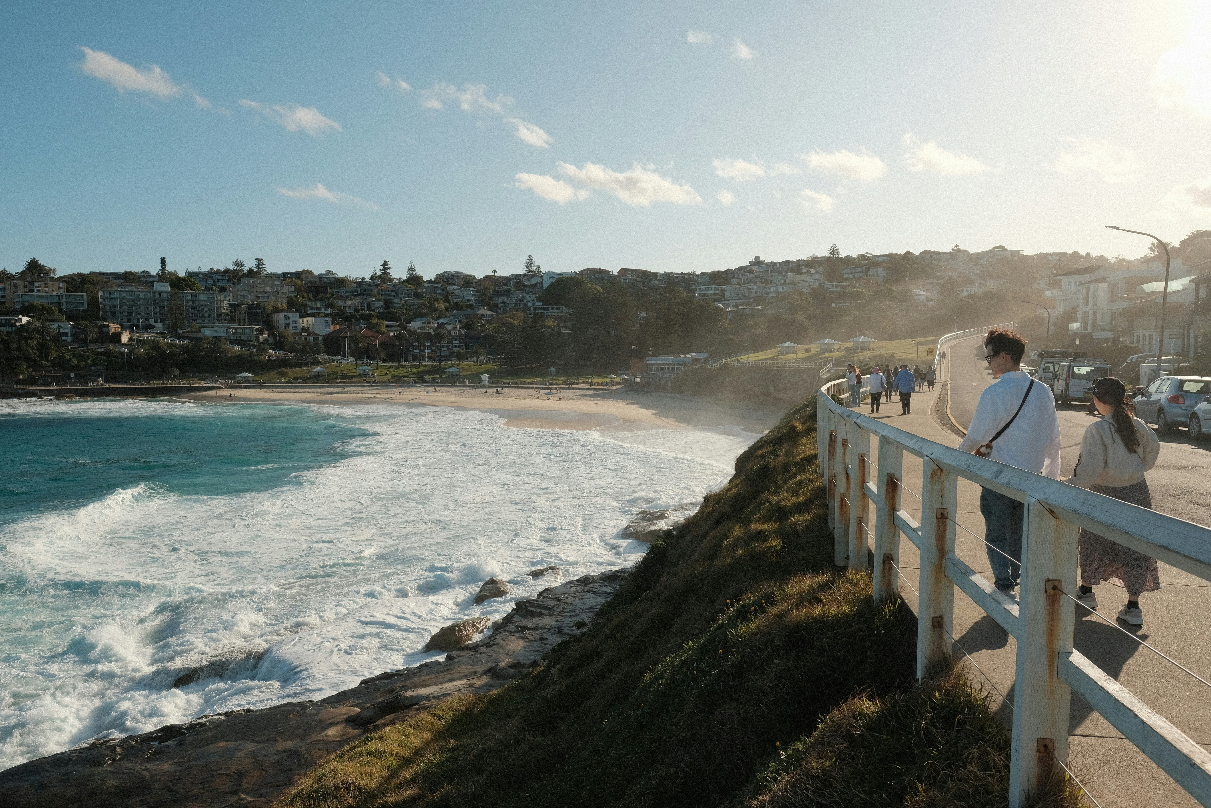 Ridge Walk at Golden Hour: Pedestrians, Railings, and the Pacific