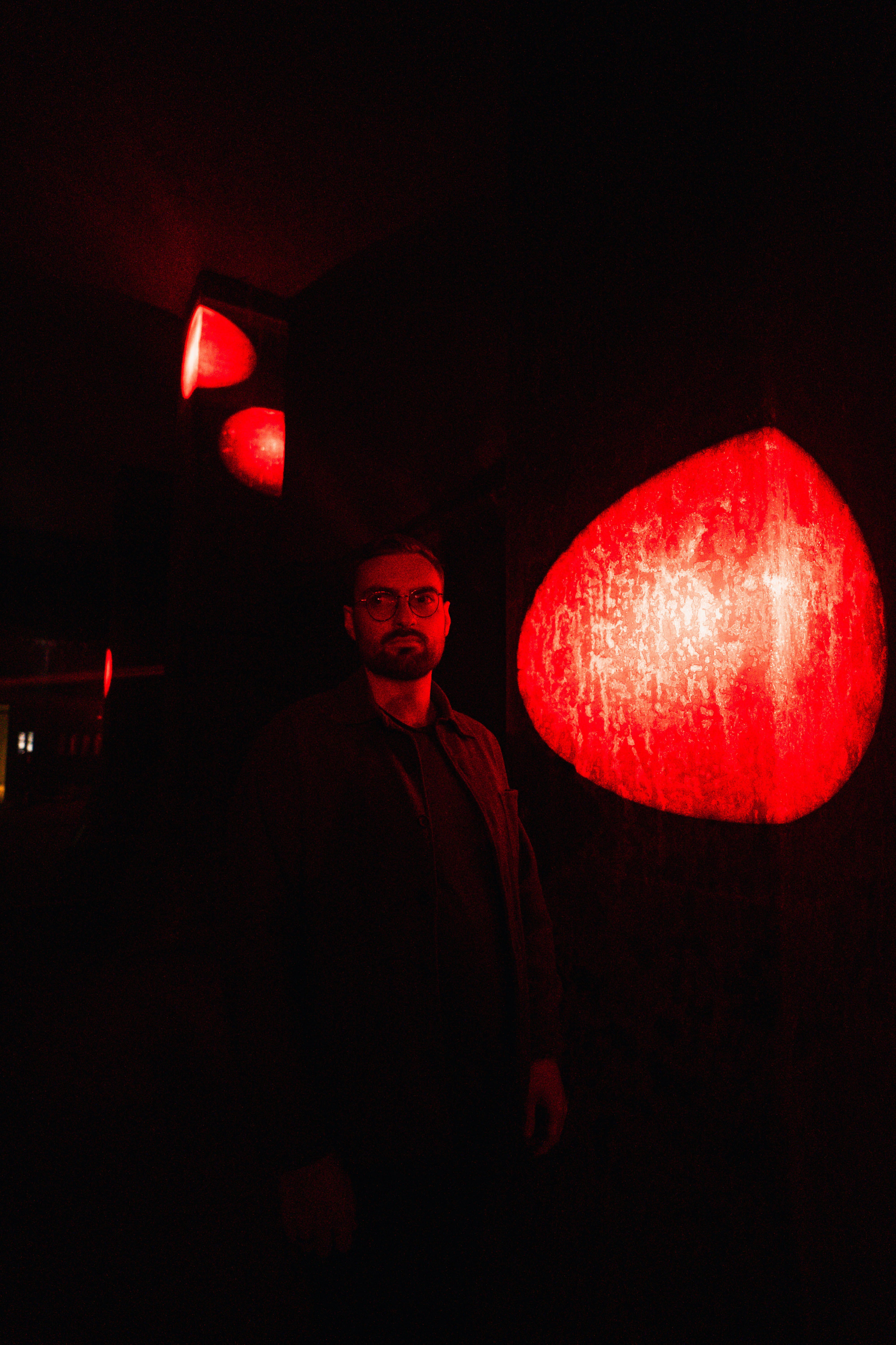 Red Glow, Quiet Figure: Portrait Under a Monumental Heart