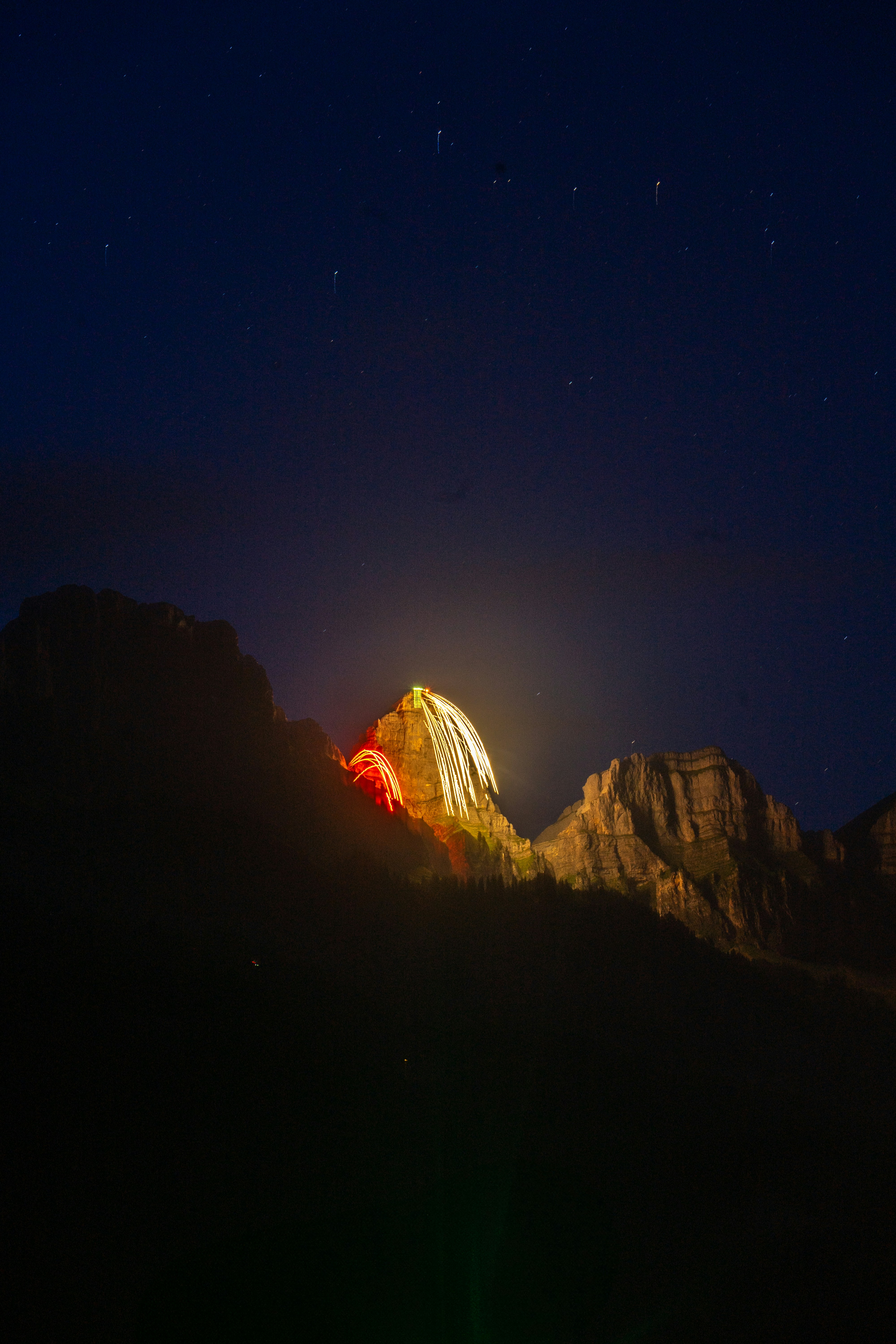 Neon Halo over the Ridge: A Starry Nightscape
