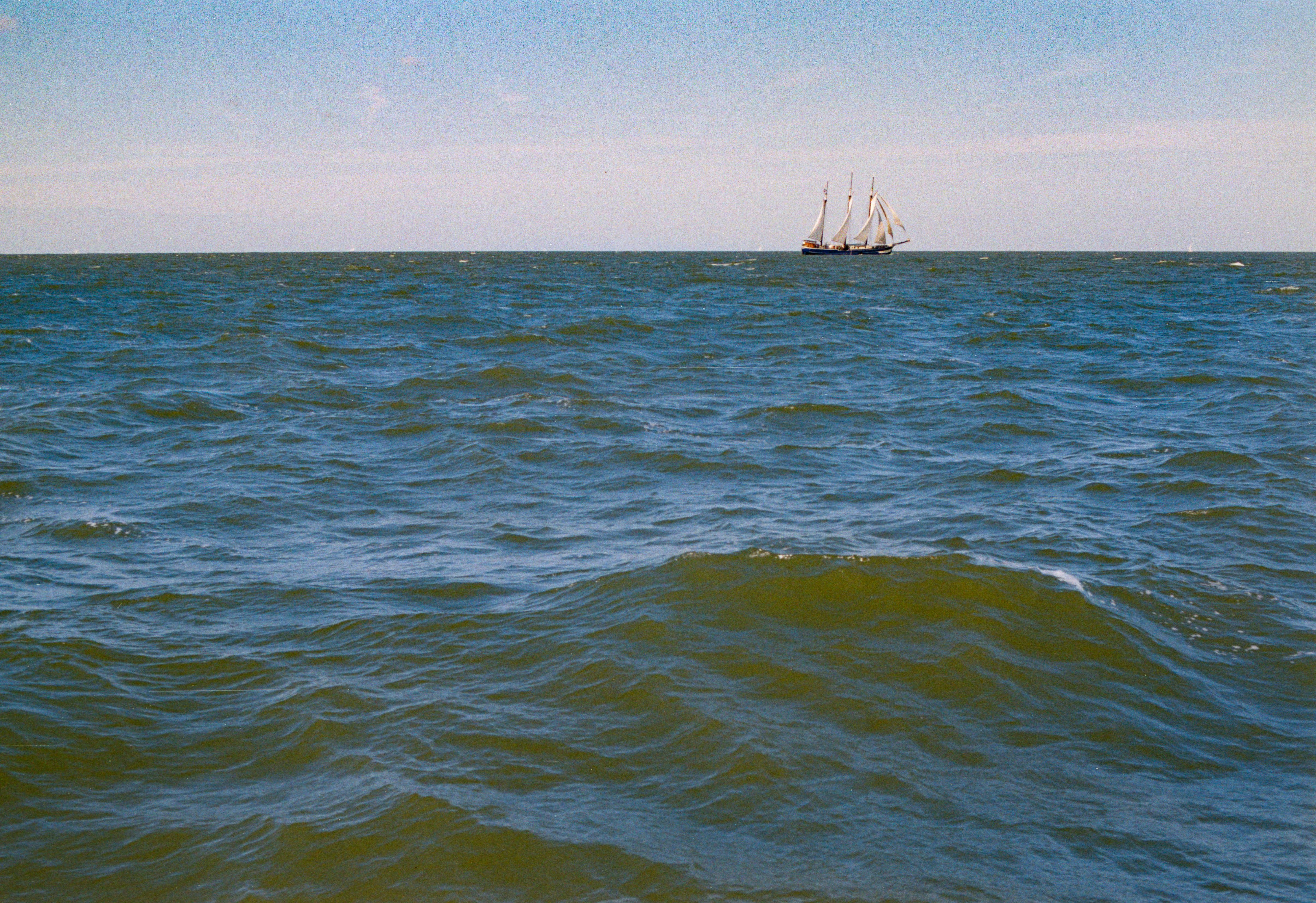 A sailboat in the middle of a large body of water