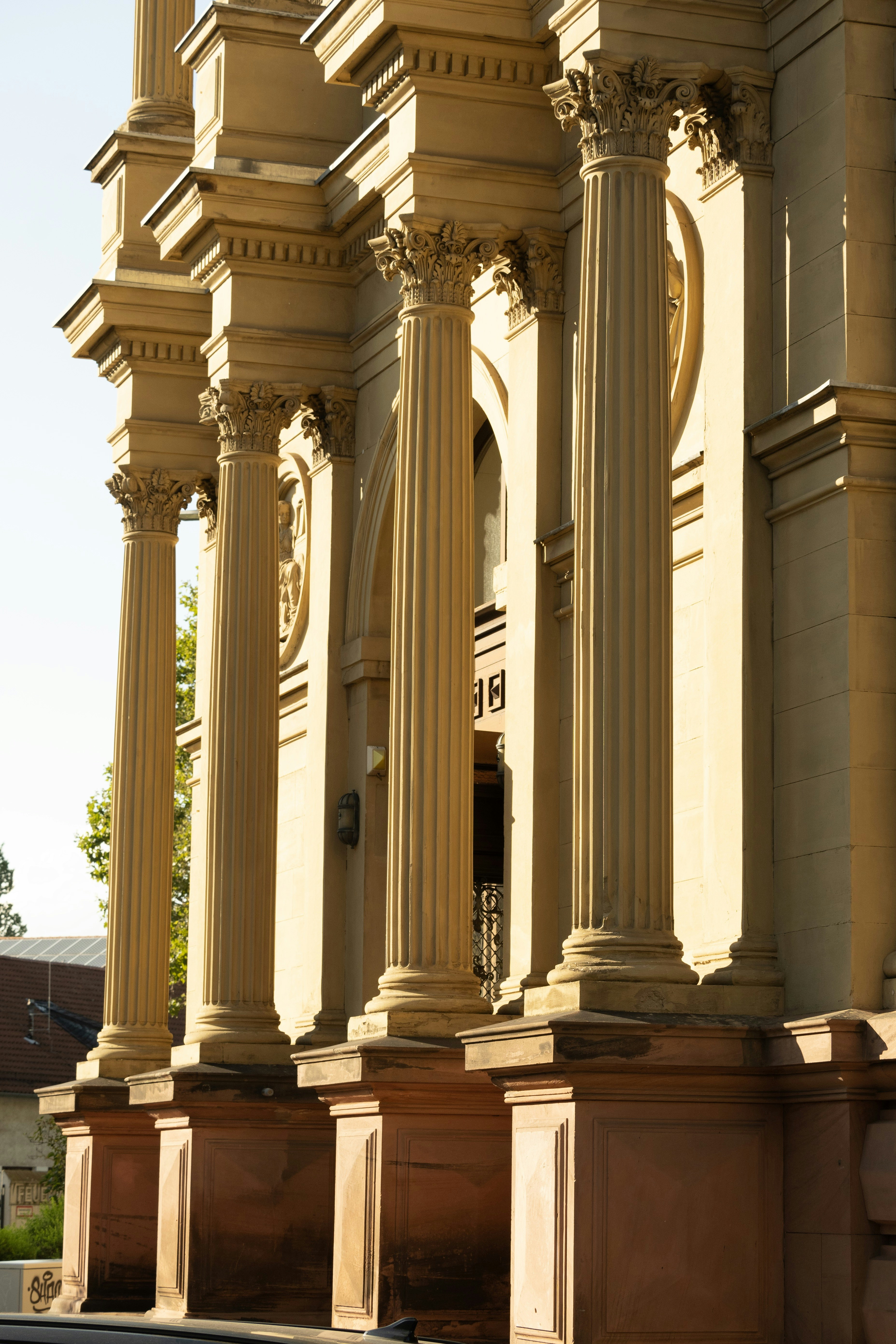 A row of large pillars next to a building photo – Free Building Image ...