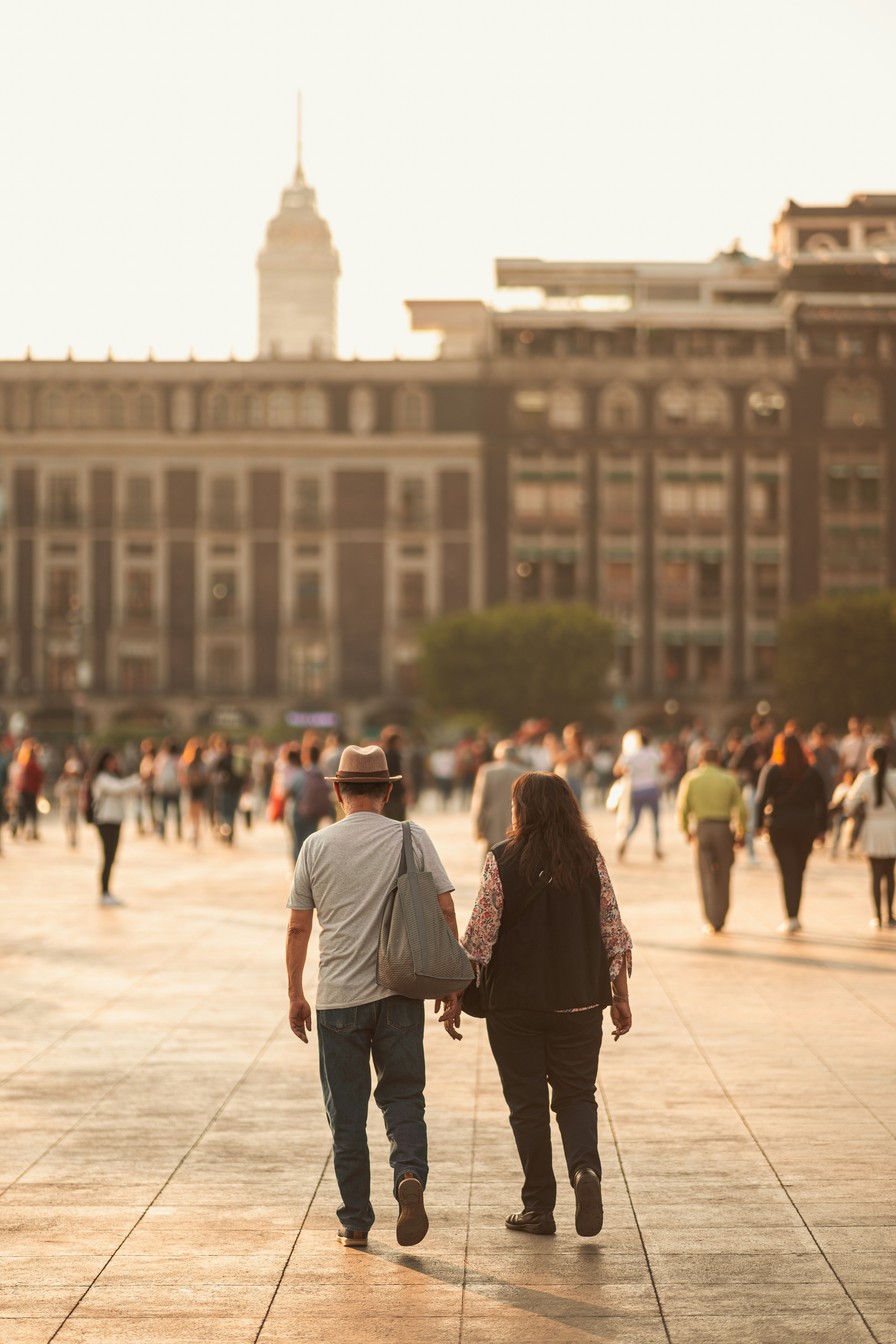 A couple of people walking down a street