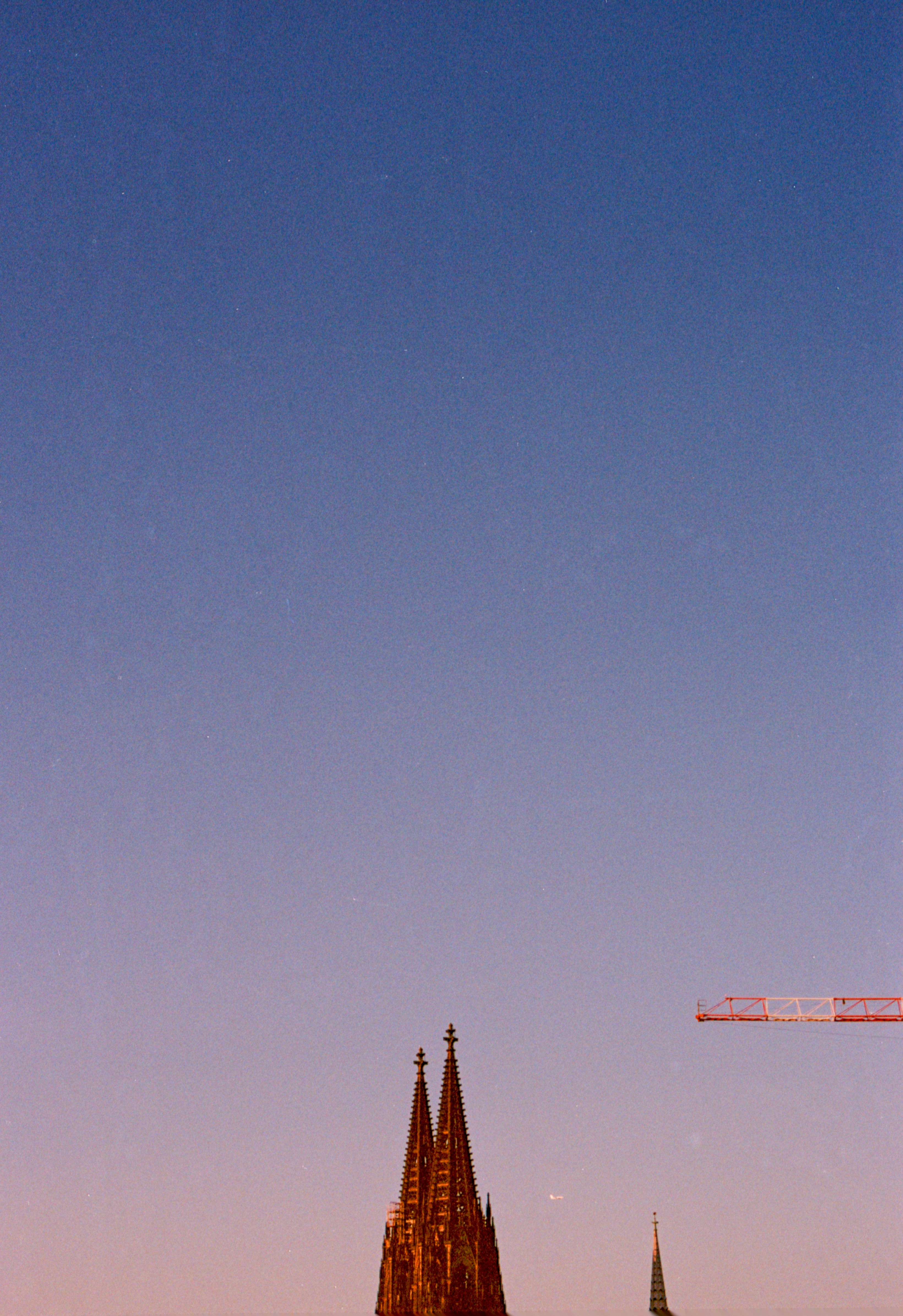 Dusk Spires and a Crane: Twilight Gothic Silhouette Over a Quiet City