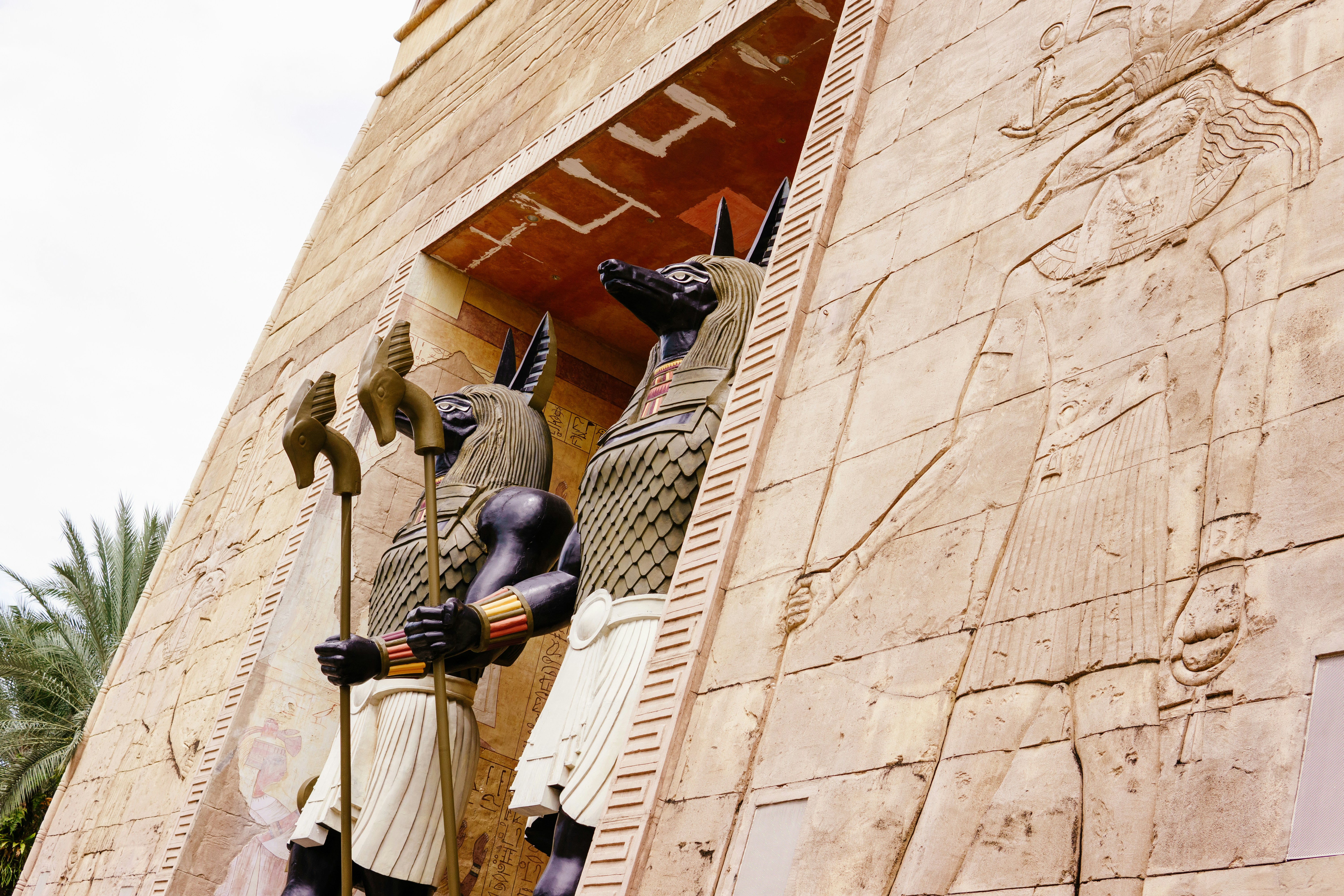Statues of egyptian gods and goddesss in front of a building photo ...