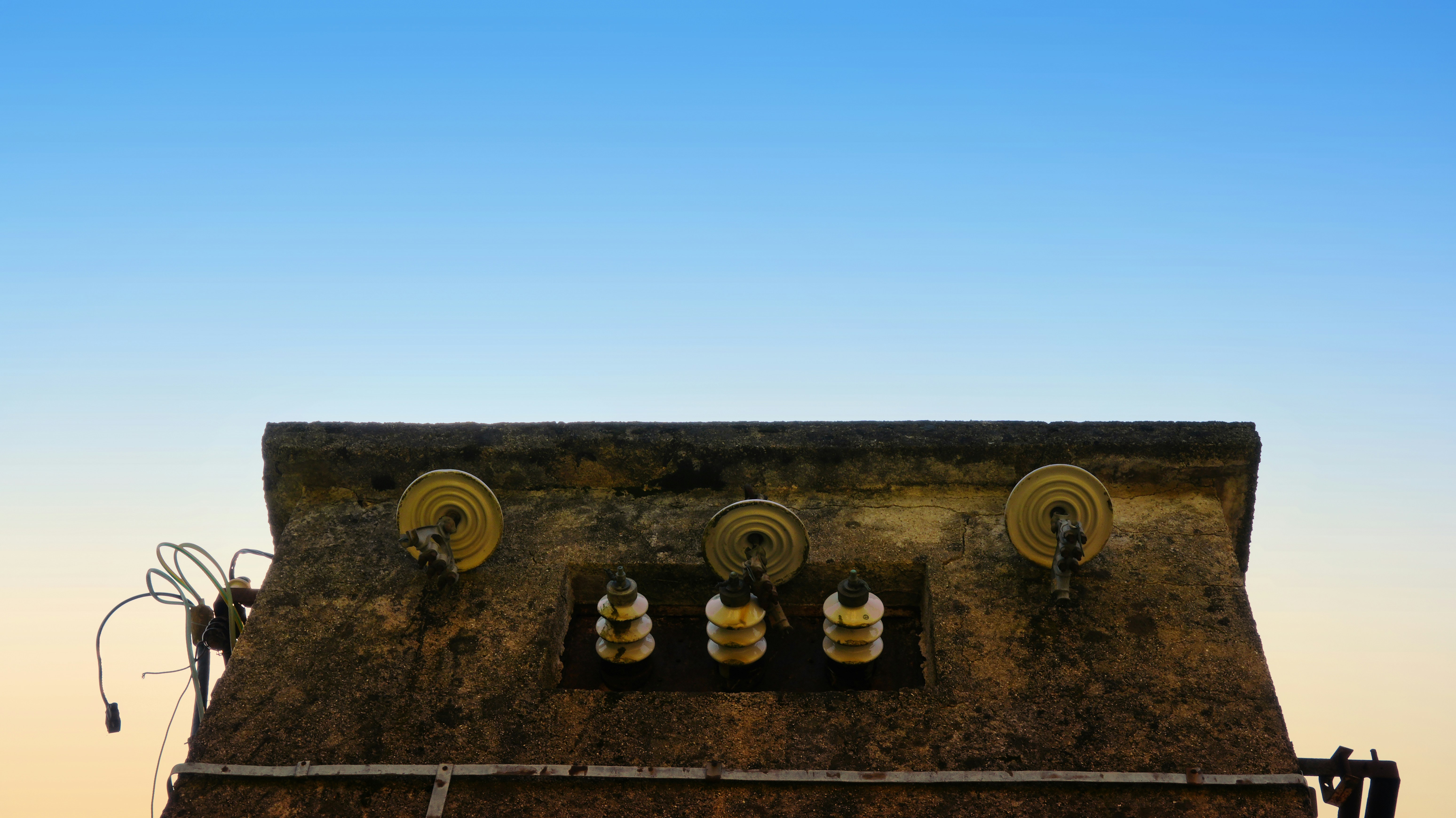 Rusted Rooftop Vent Array Quietly Anchored Against a Cerulean Gradient