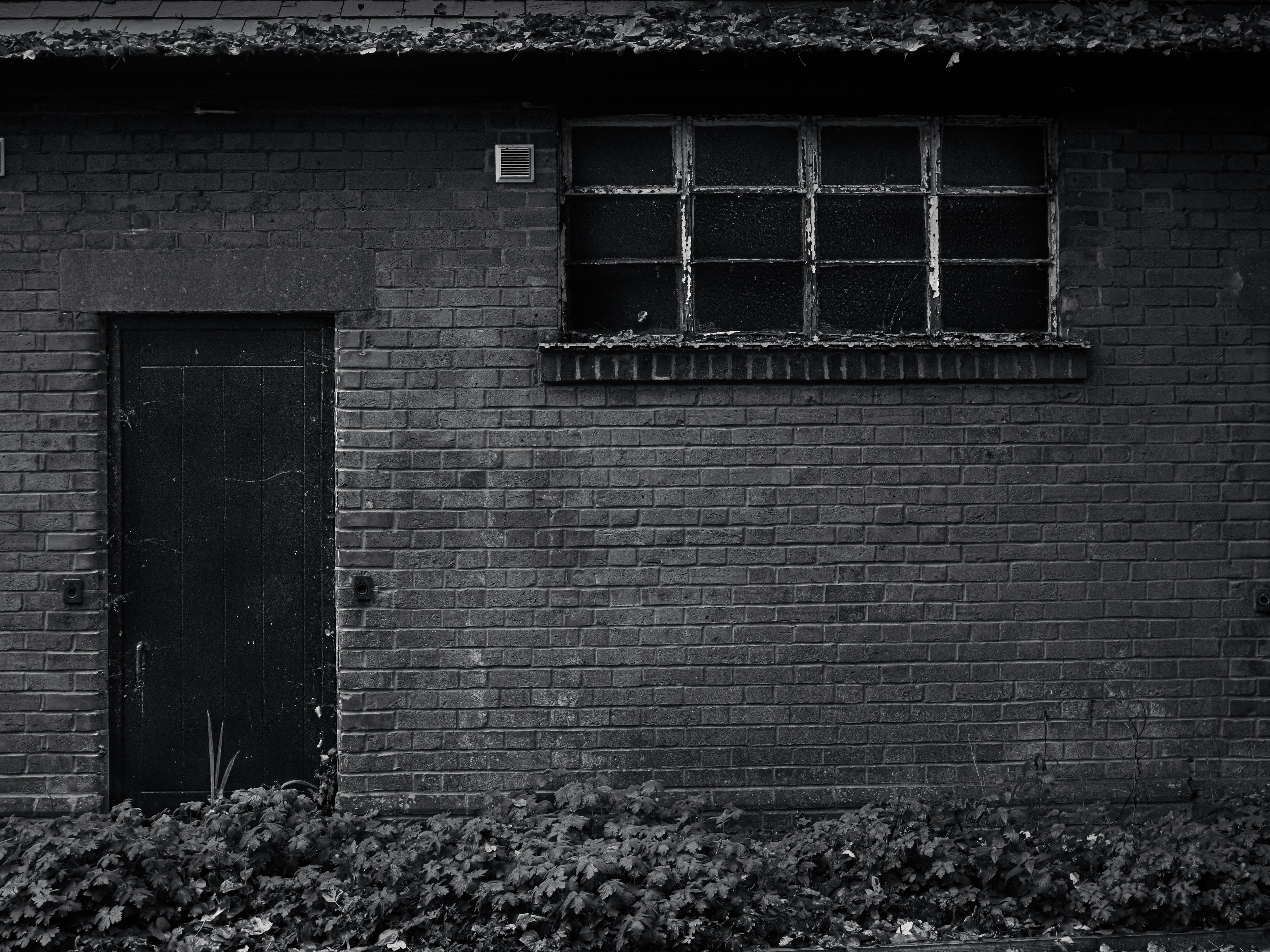 A black and white photo of a brick building photo – Free Brick Image on ...