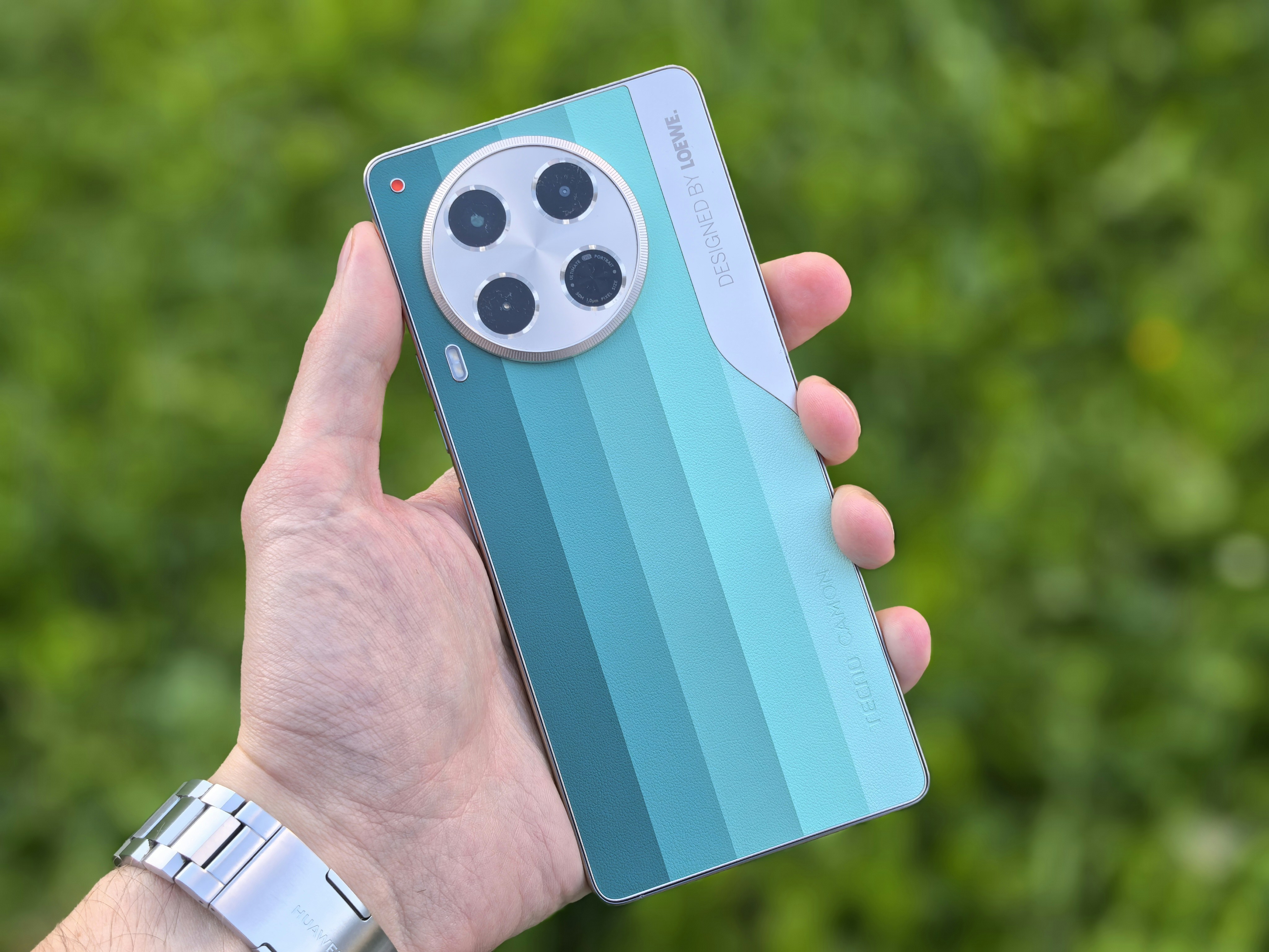 Quad-Camera Halo on a Mint Gradient: Hand-Held Huawei Pura 70